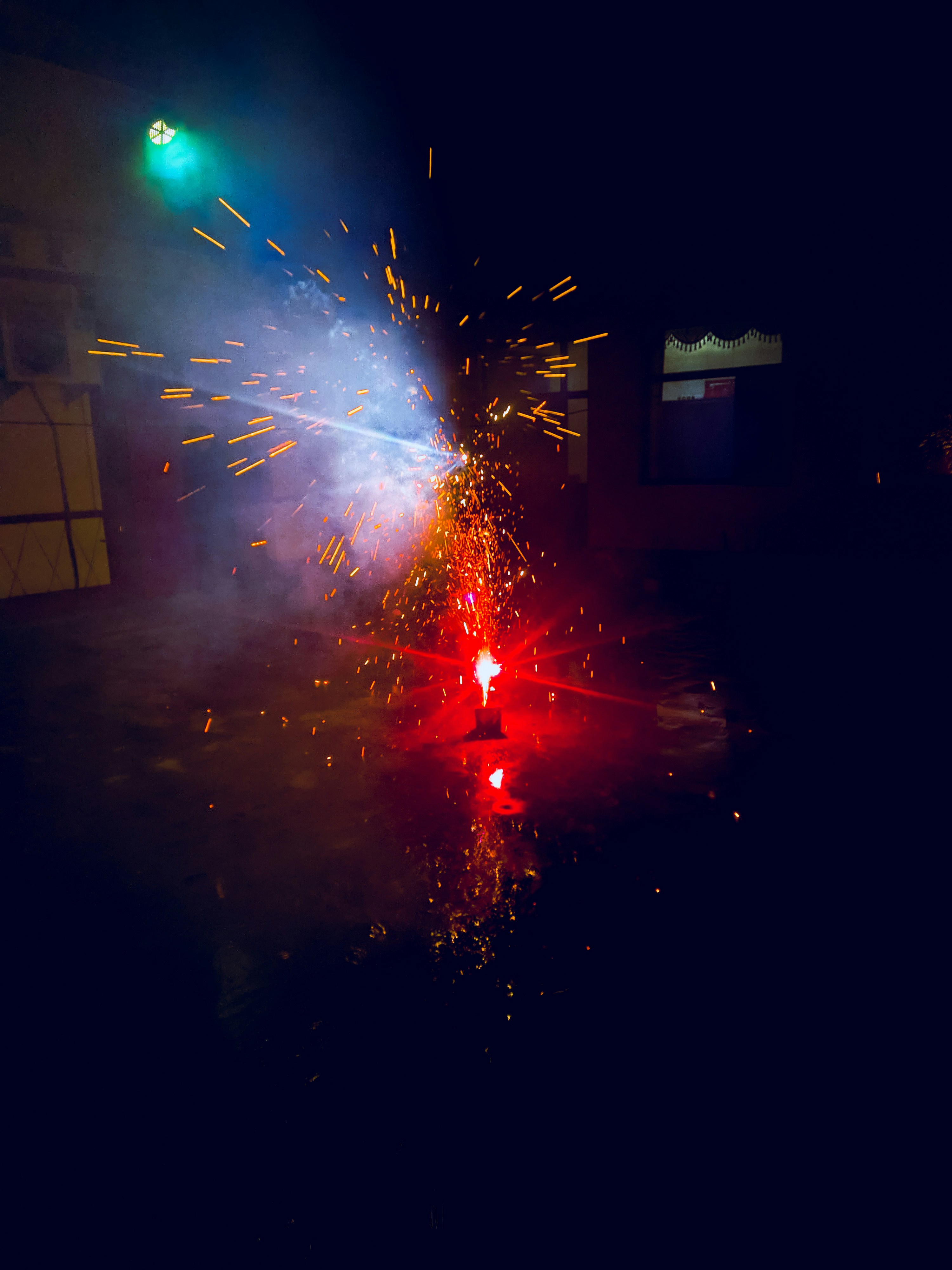 Crimson Core Sparks: A Nighttime Fountain of Blue and Red
