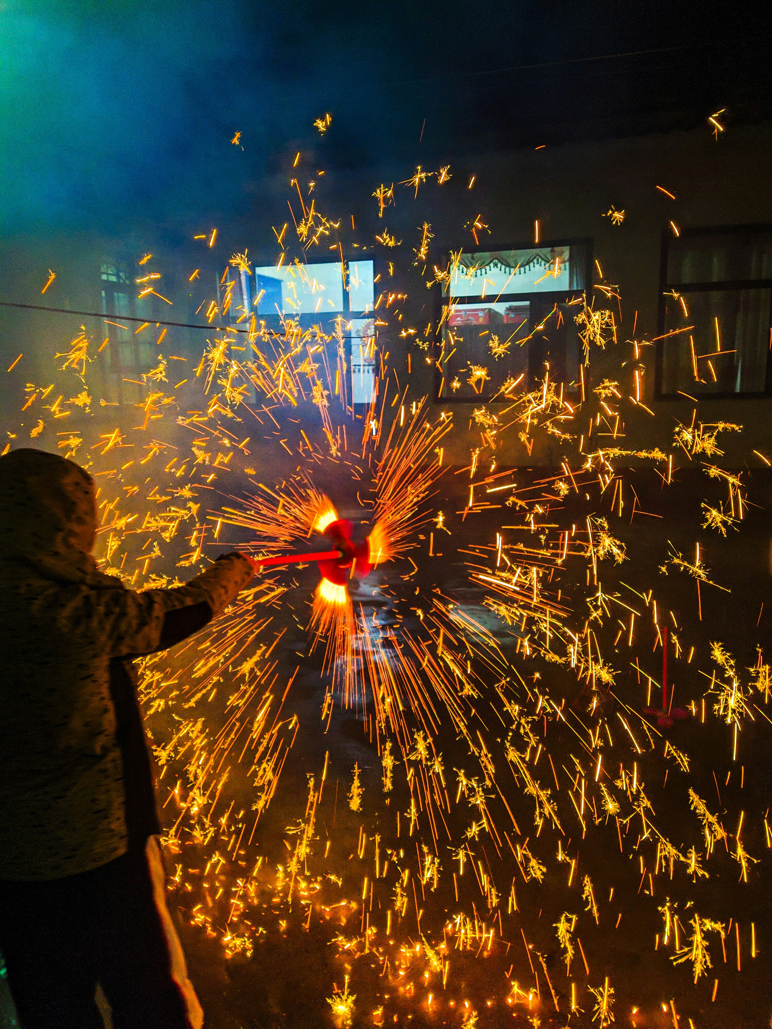 Spinning Sparks: Handheld Ember Rain in a Dim Workshop