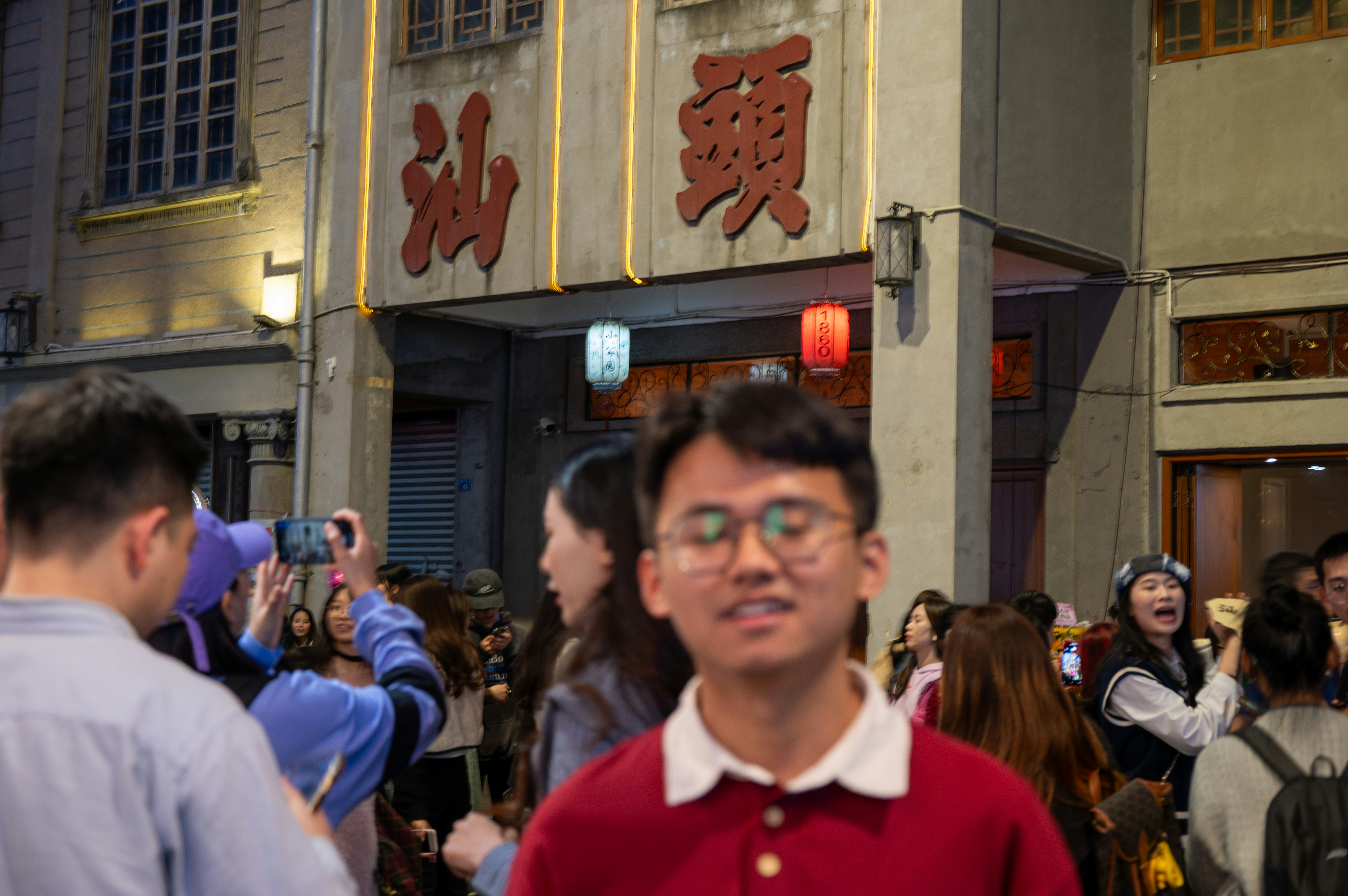 Red-shirted Blur Through a Lantern-Lit Chinatown Night Market