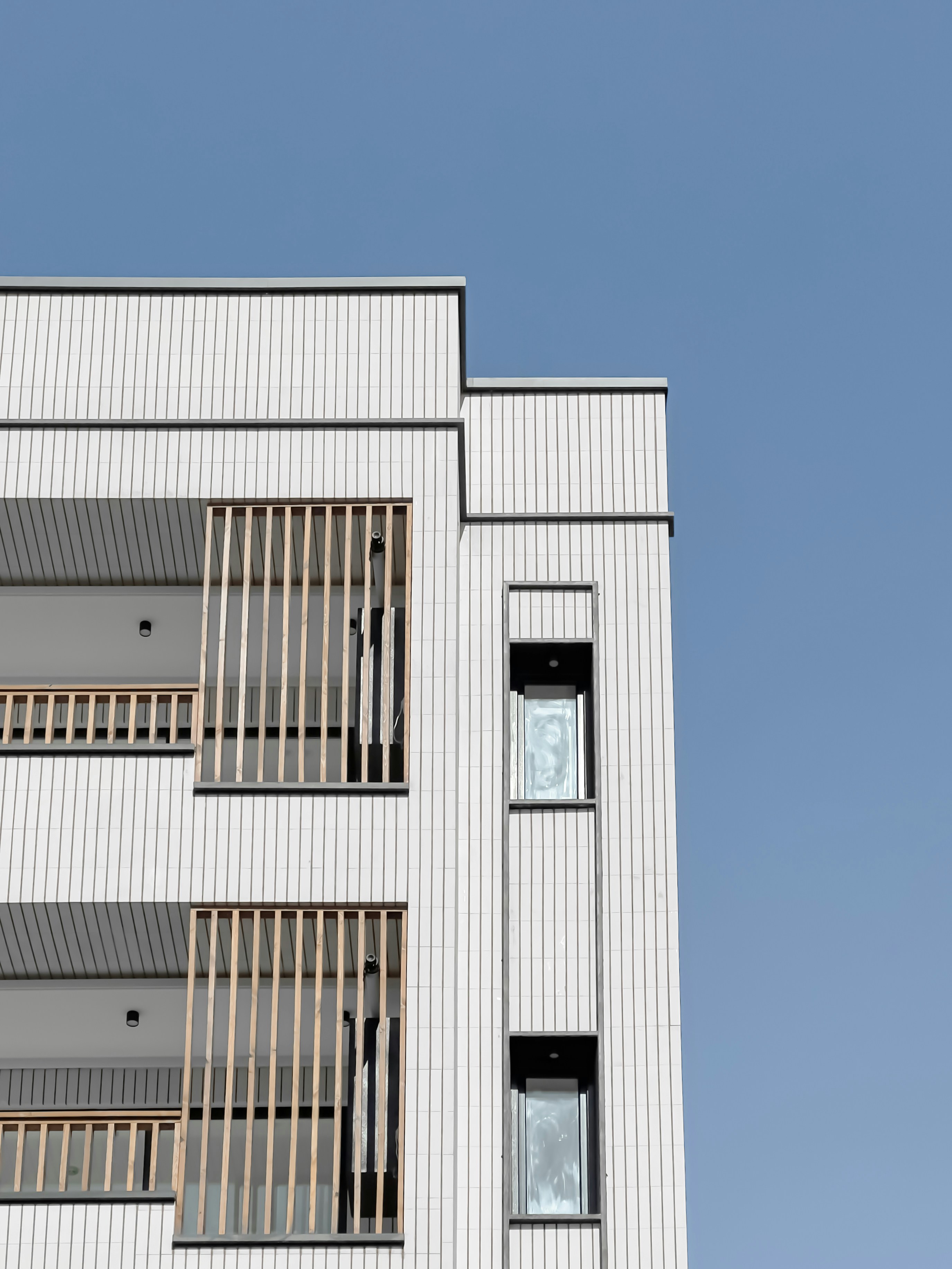 A tall white building with balconies and windows photo – Free Grey ...