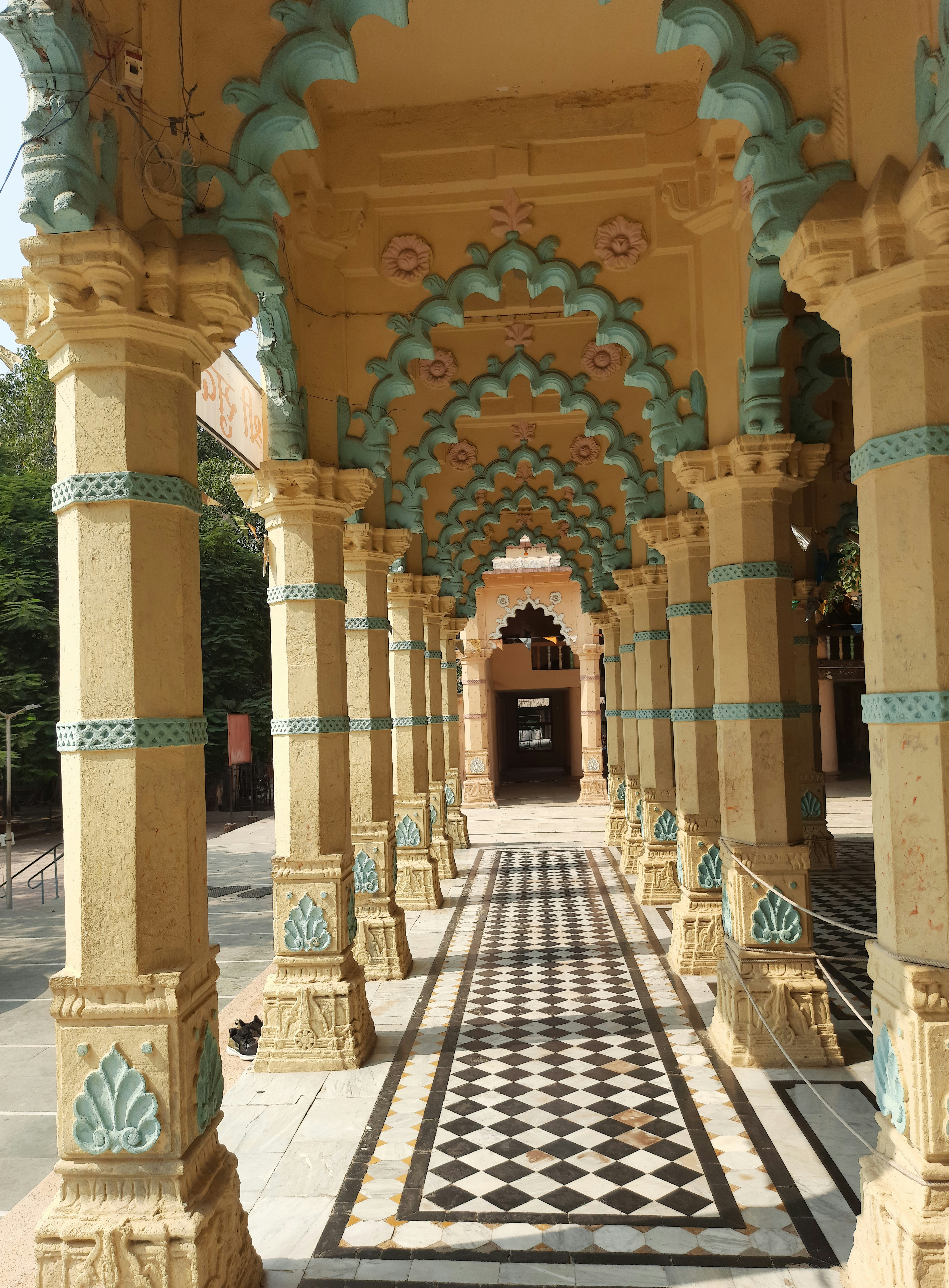 A large building with a checkered floor and pillars photo – Free ...