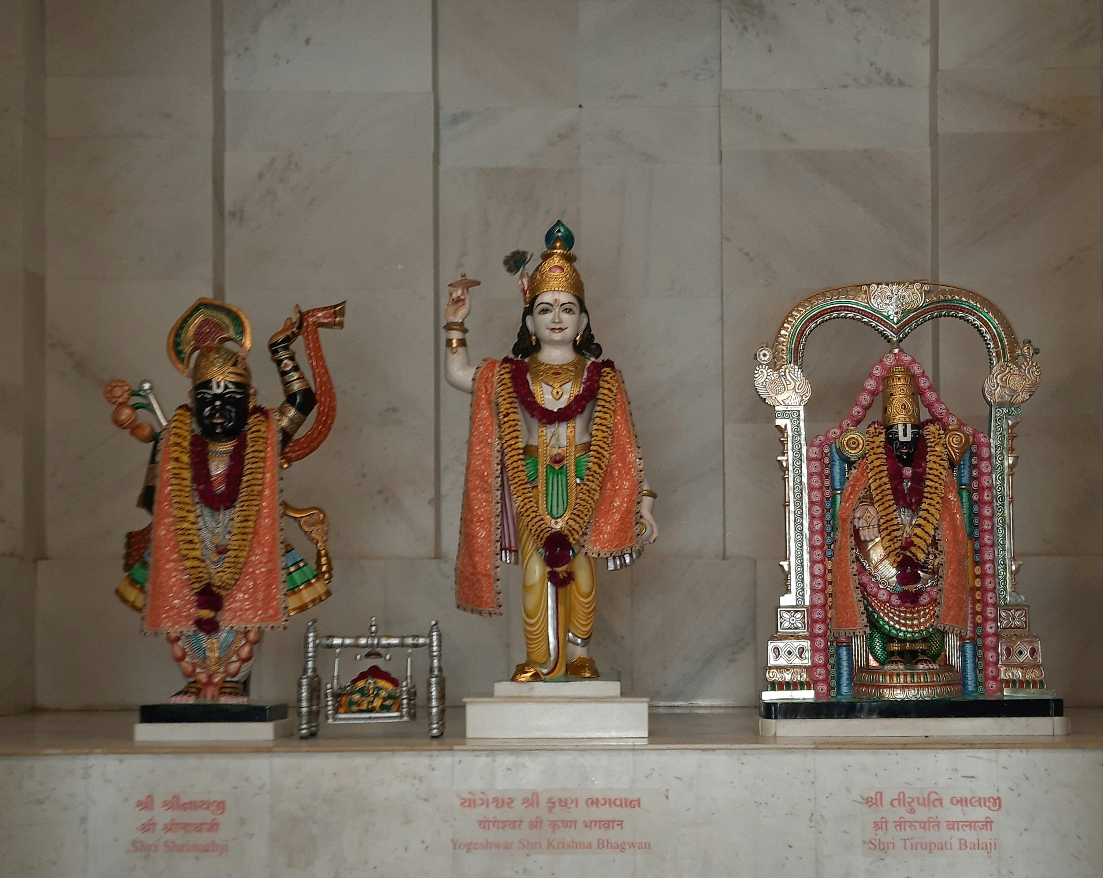 Three statues of hindu deities on display in a room photo – Free Bride ...
