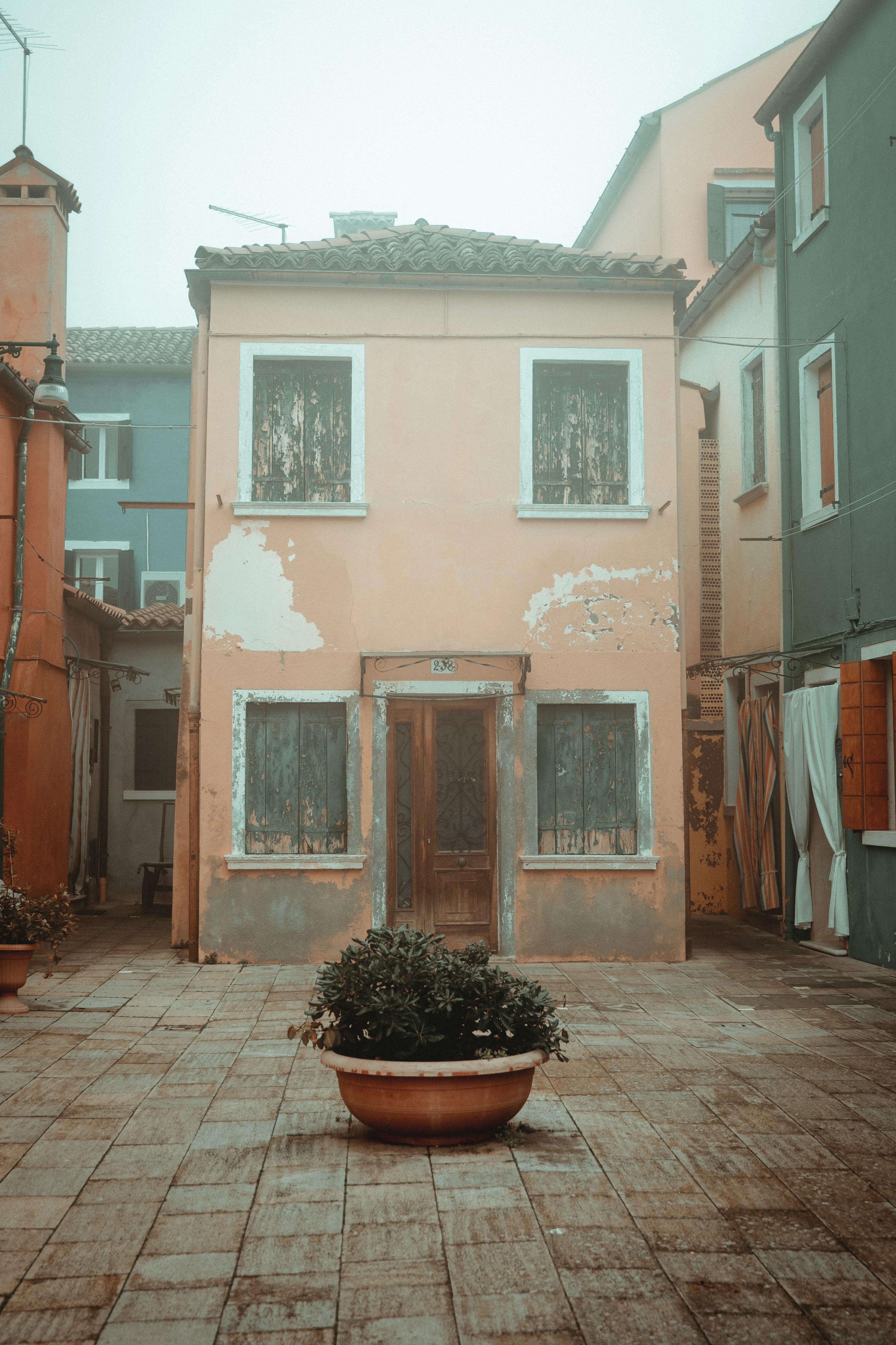 The Doorway in the Peach Facade: A Weathered Courtyard Portrait