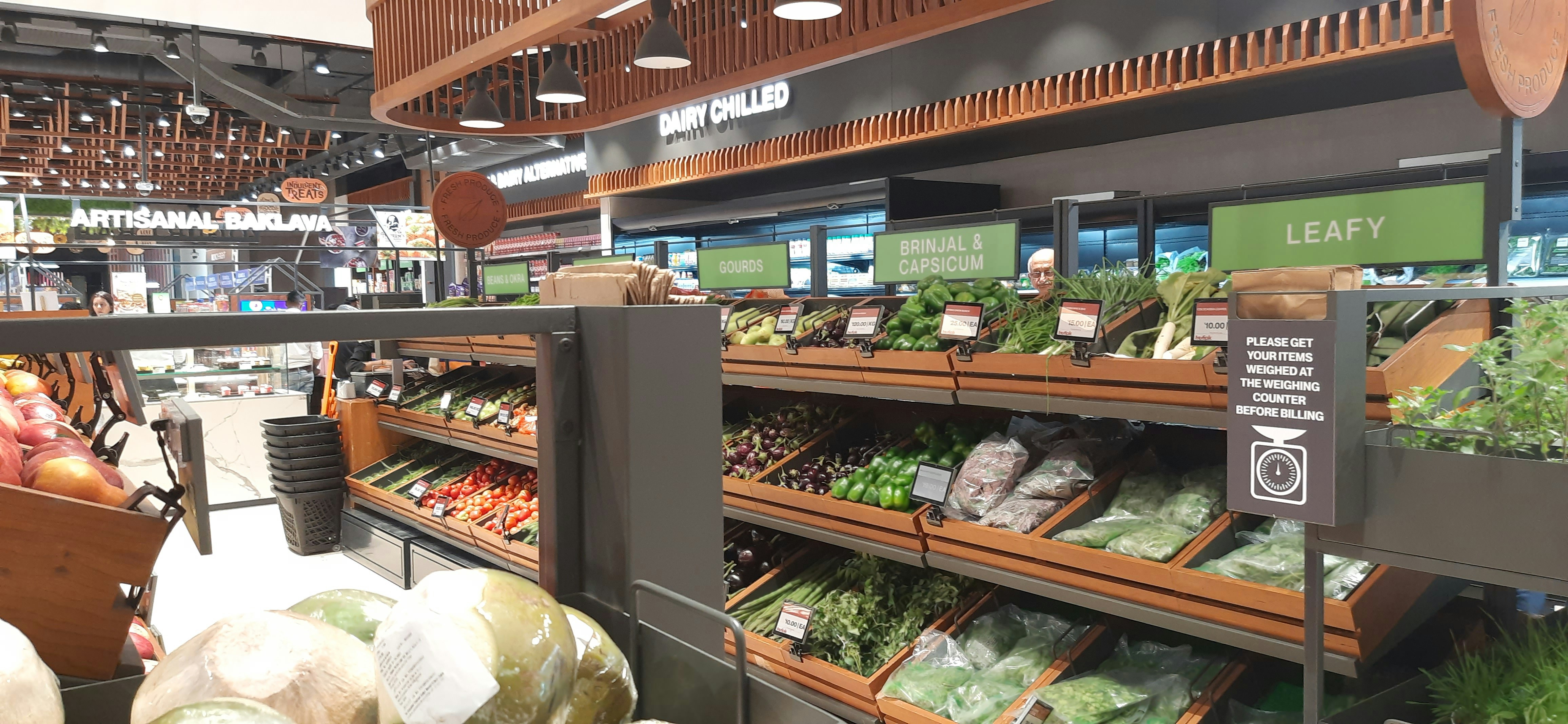 Produce Aisle at Eye Level: Fresh Greens and Colorful Bins