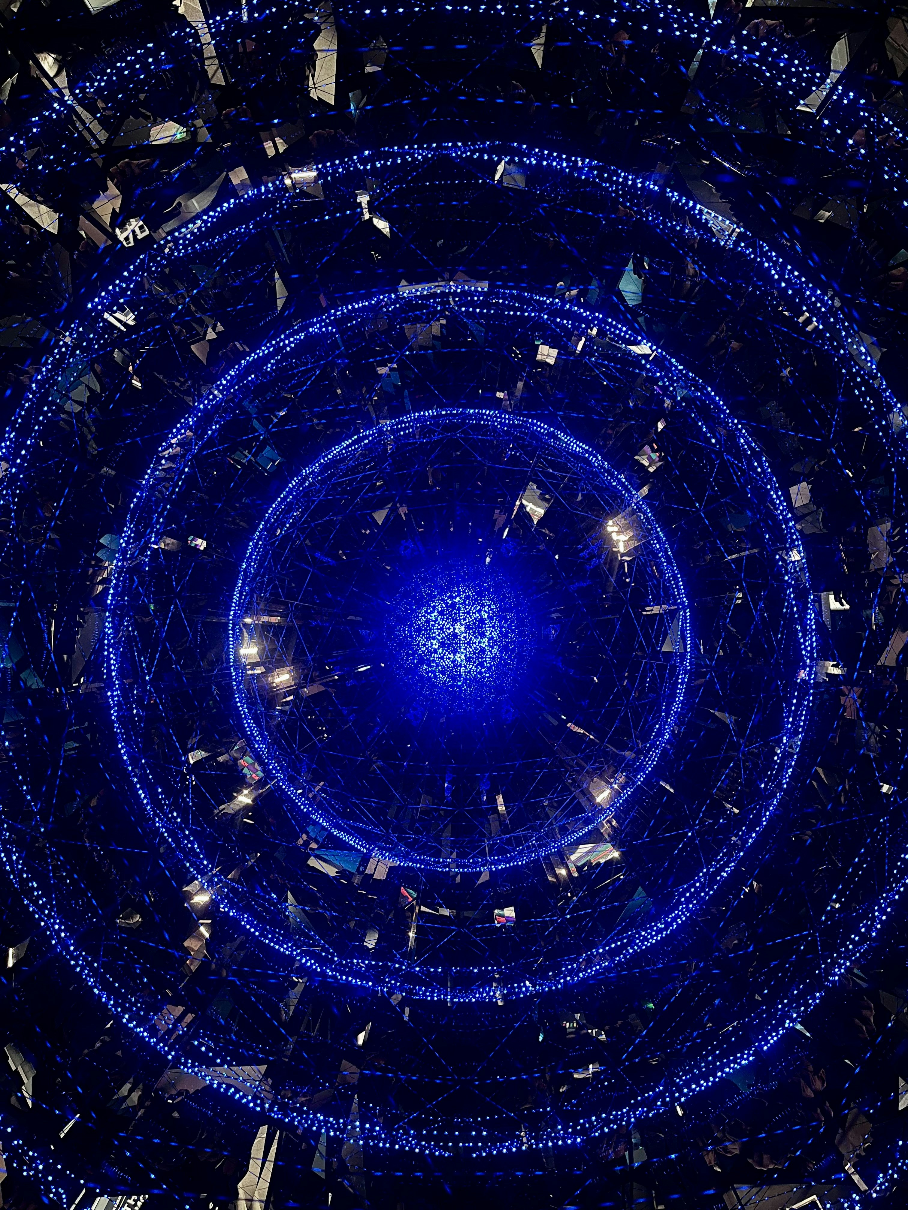 A very large blue object with many small objects around it photo – Free ...