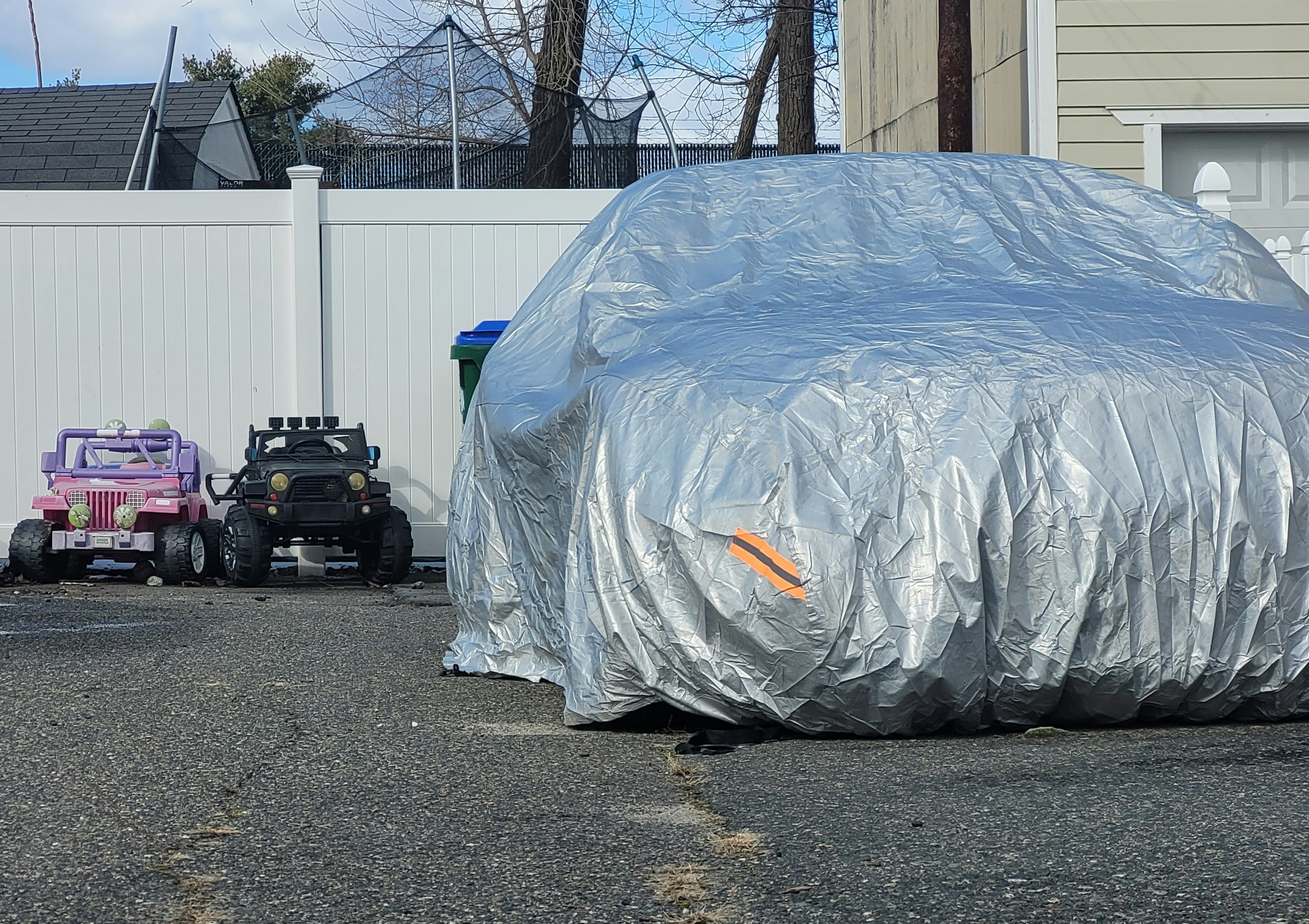 A car covered in a tarp in a driveway photo – Free Grey Image on Unsplash