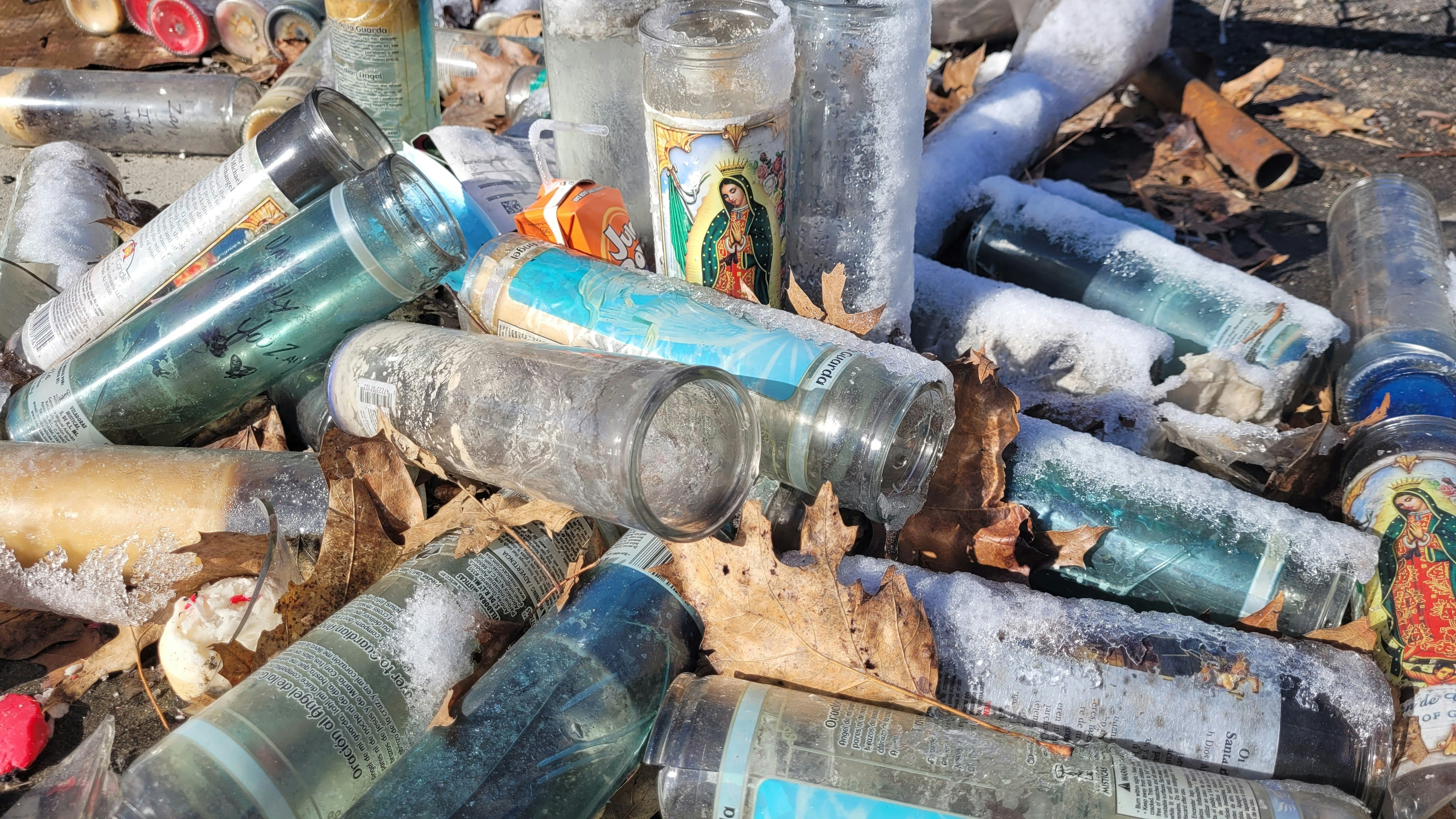a pile of empty plastic bottles sitting on top of a pile of wood