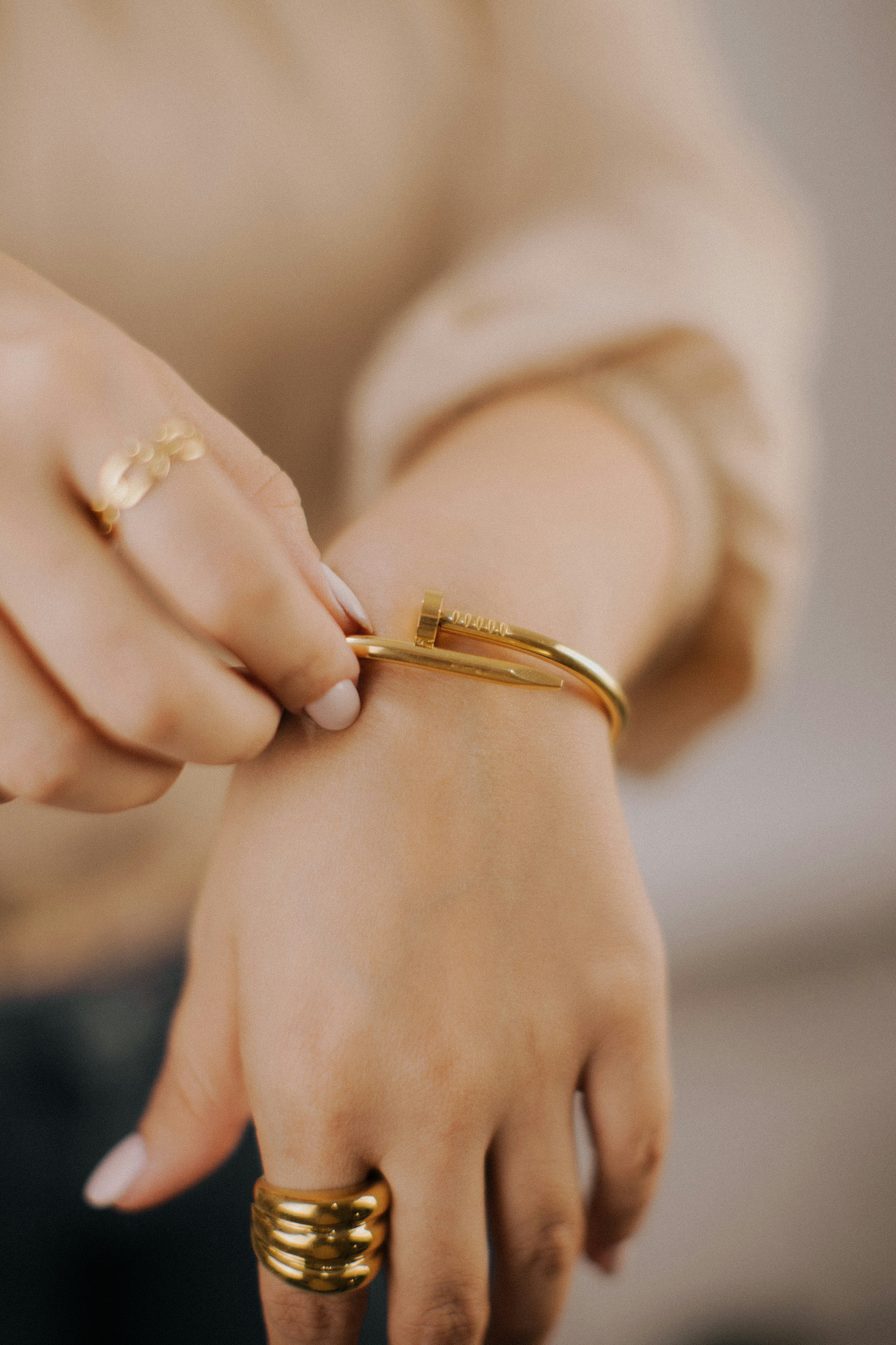A woman is holding onto a gold ring photo – Free Jewelry Image on Unsplash