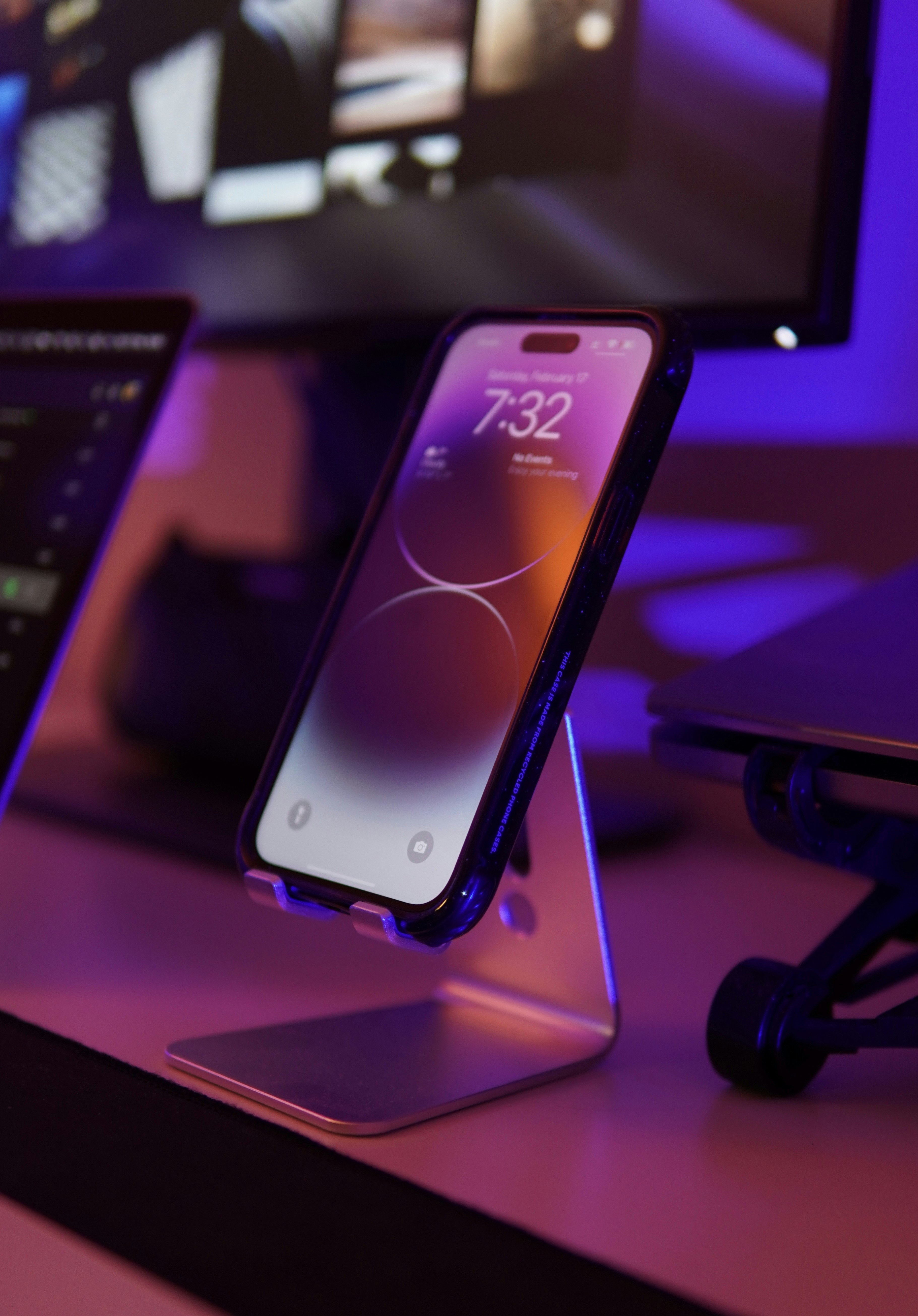A cell phone on a stand in front of a computer photo – Free Wallpaper ...
