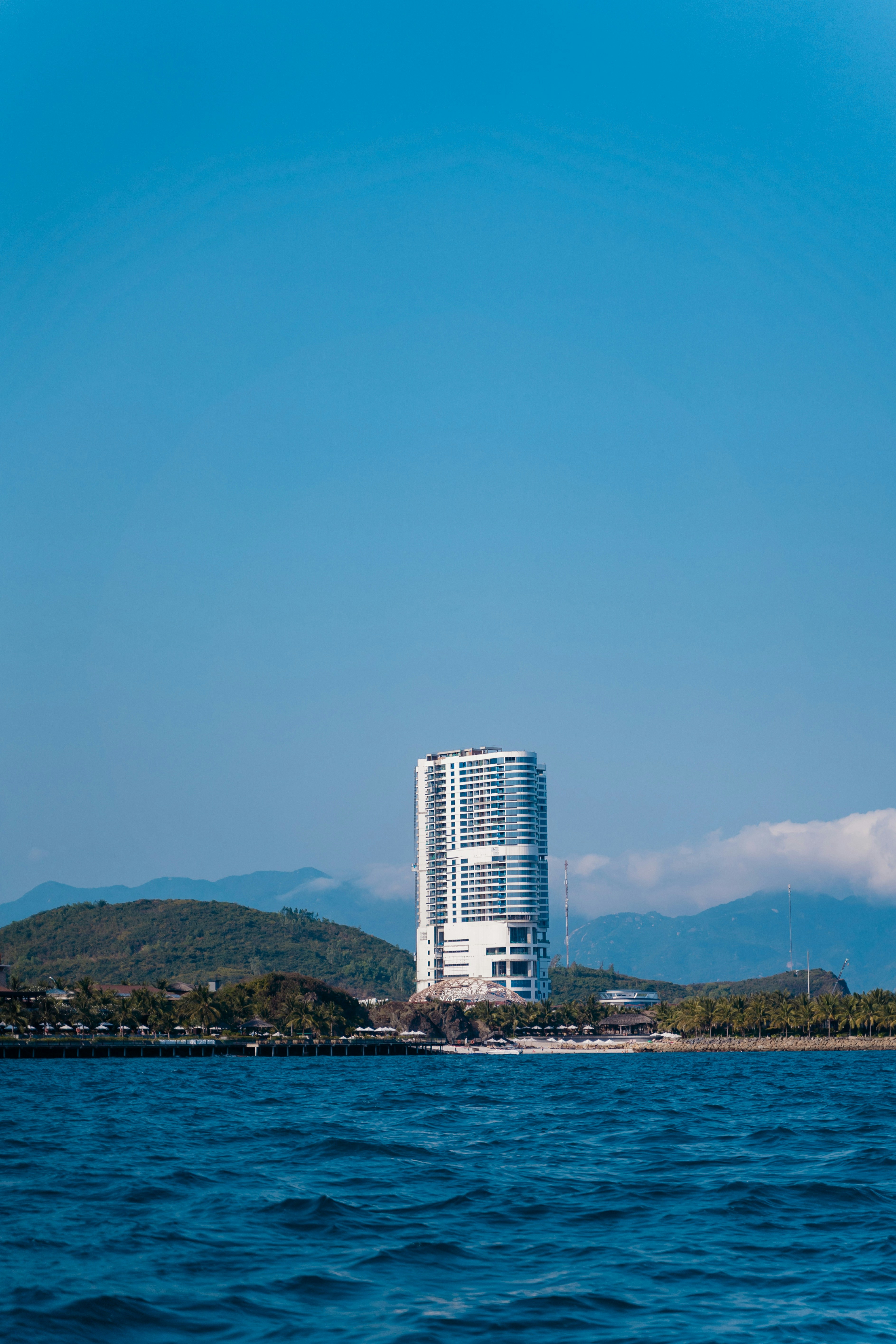 a tall building sitting on top of a large body of water