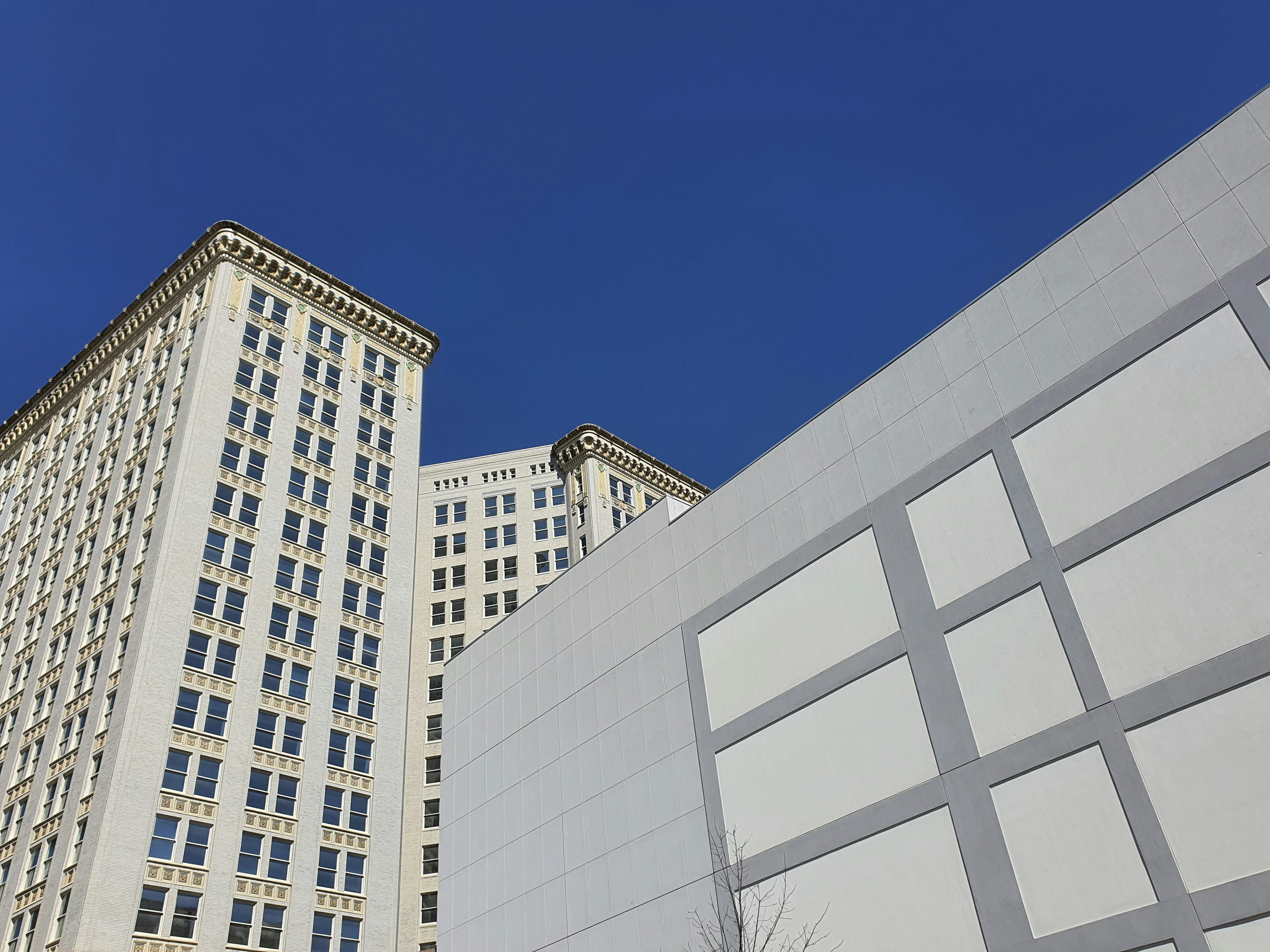 A large white building sitting next to a tall white building photo ...