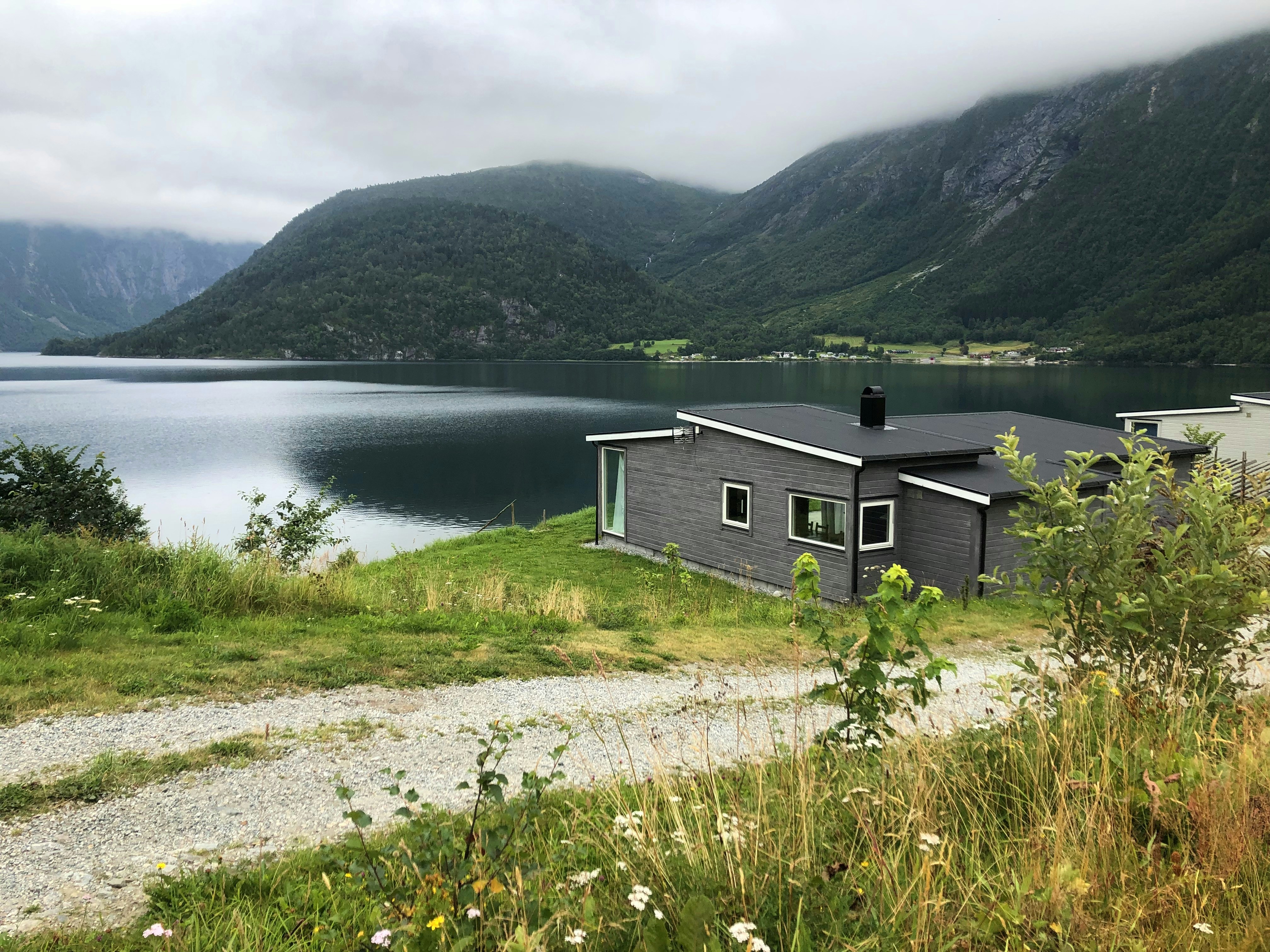 Cabin at the Fjord Edge: Quiet Frame of Mountain and Water