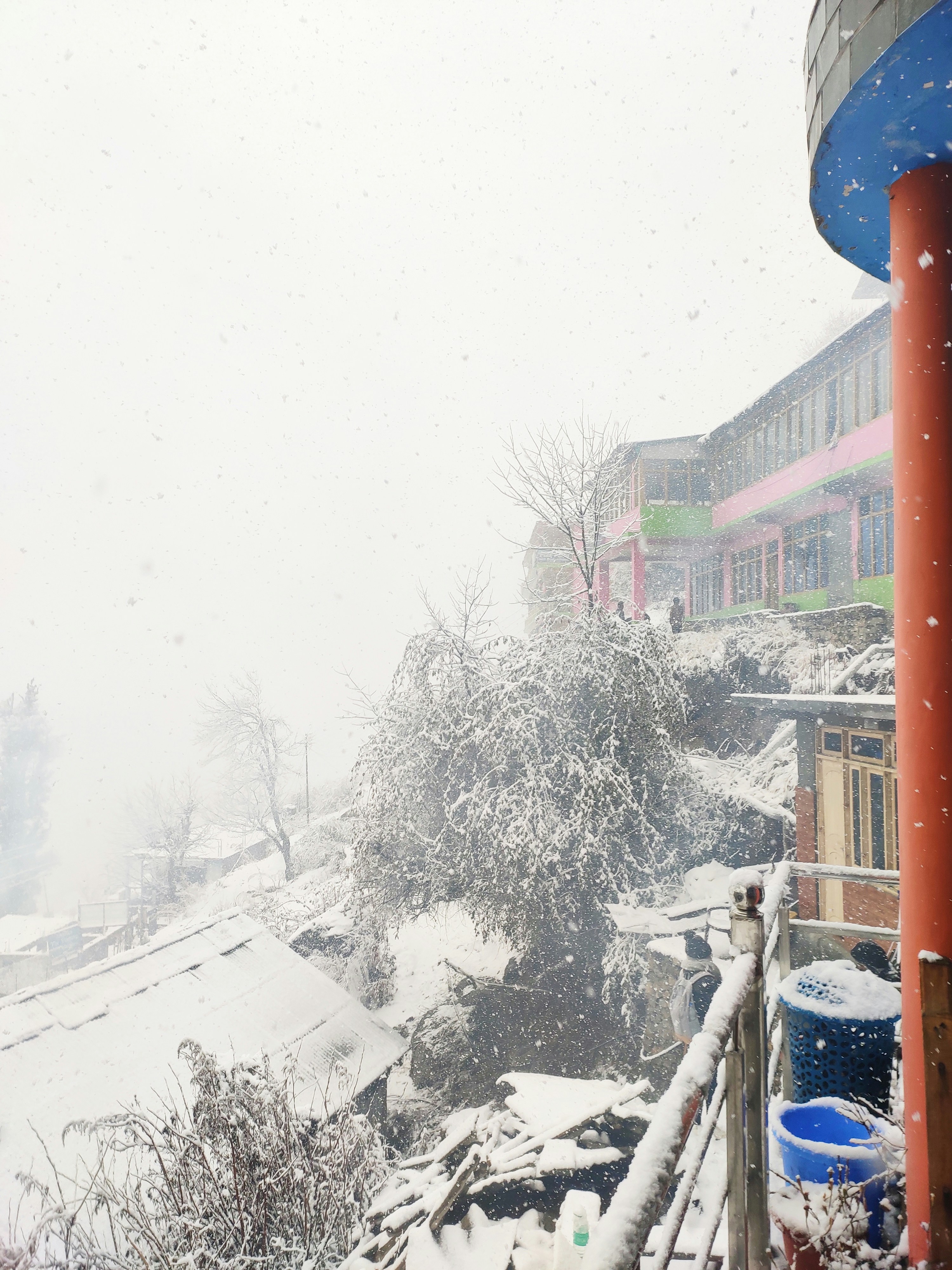 Snowy balcony overlook: a village veiled in white