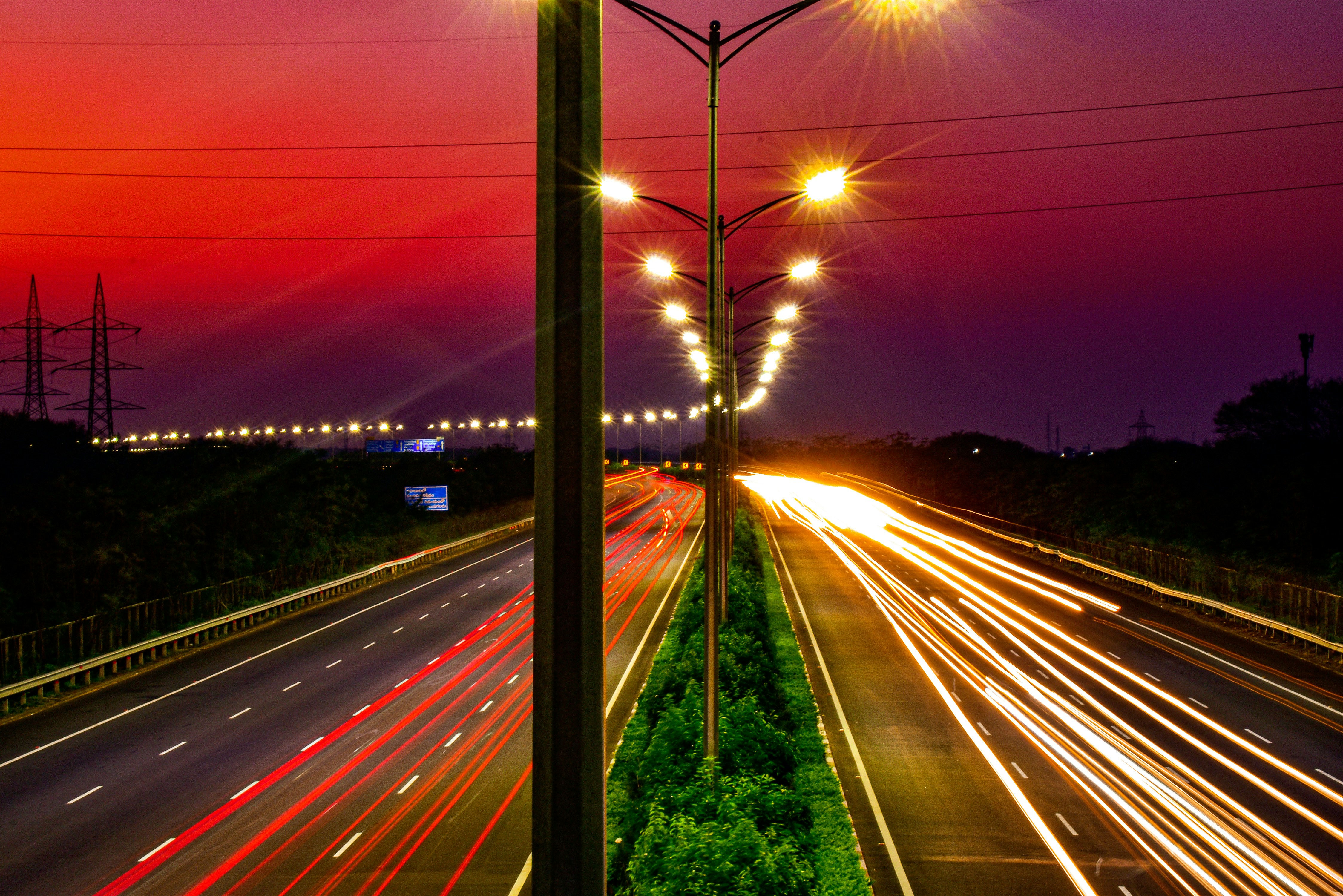 A city street at night with street lights photo – Free Road Image on ...