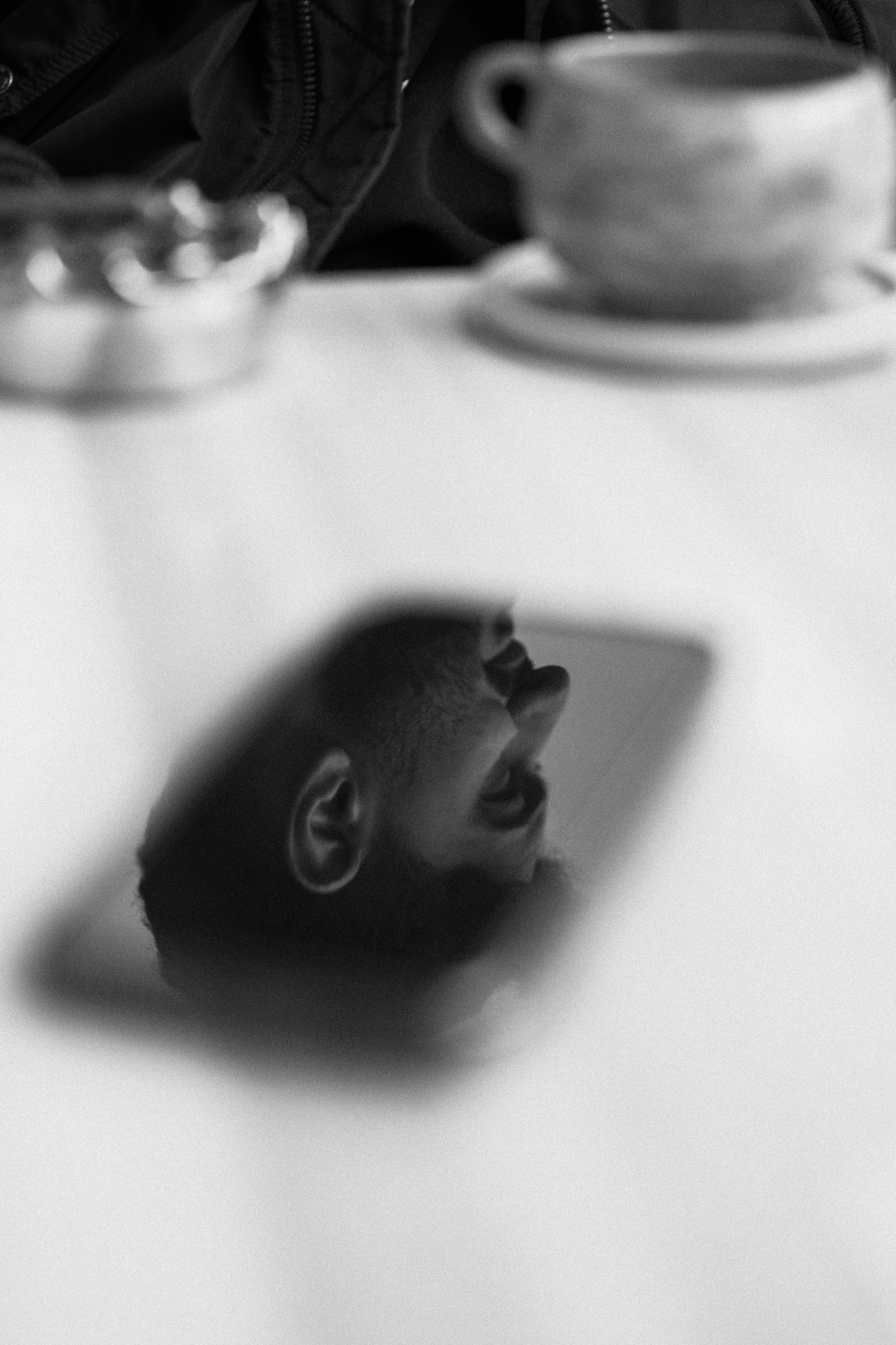 Tea-time Glass: a reflective moment between cup, screen, and silhouette