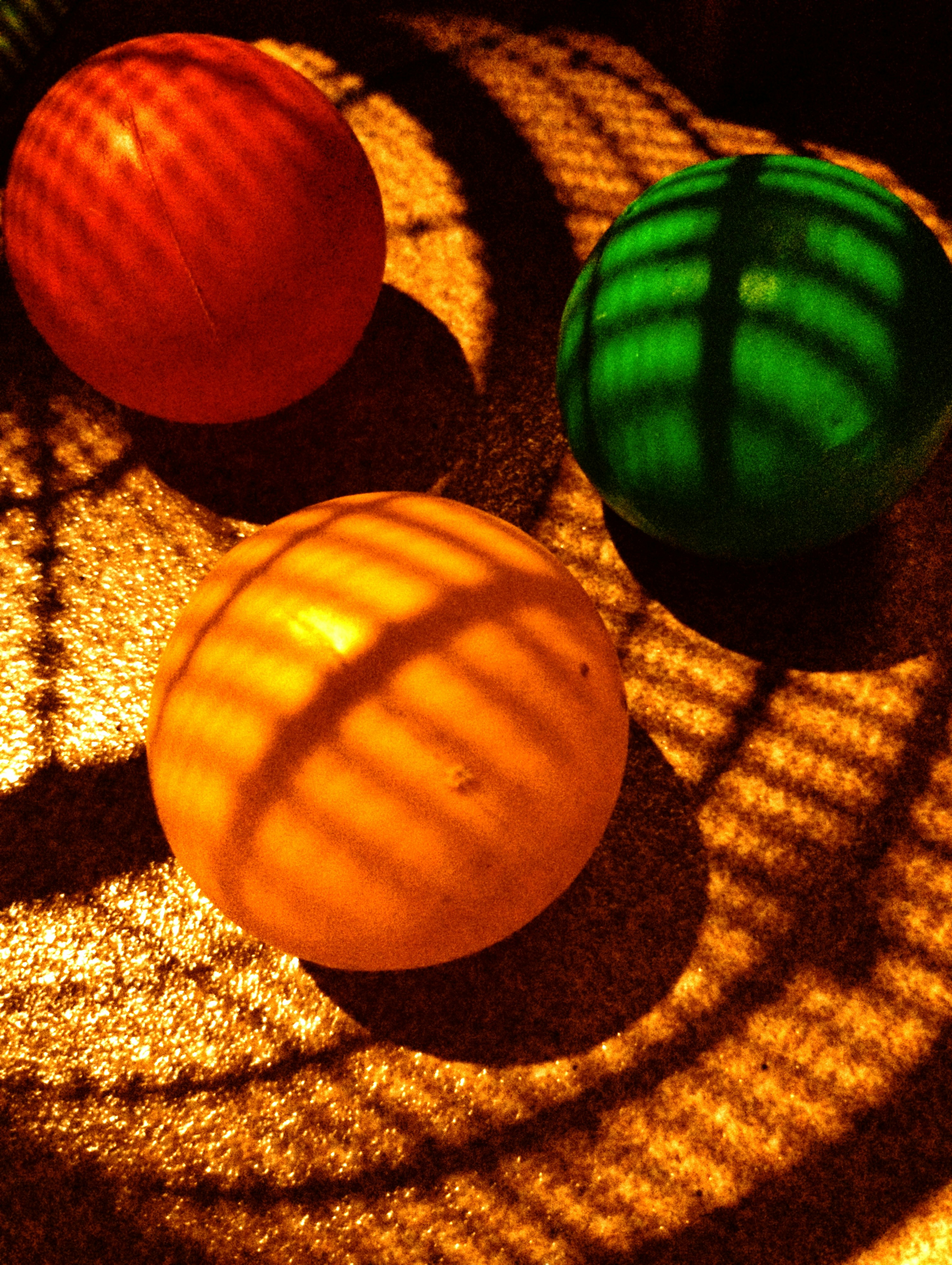 Shadows and Color Rings: A Trio of Orbs on a Golden Pattern