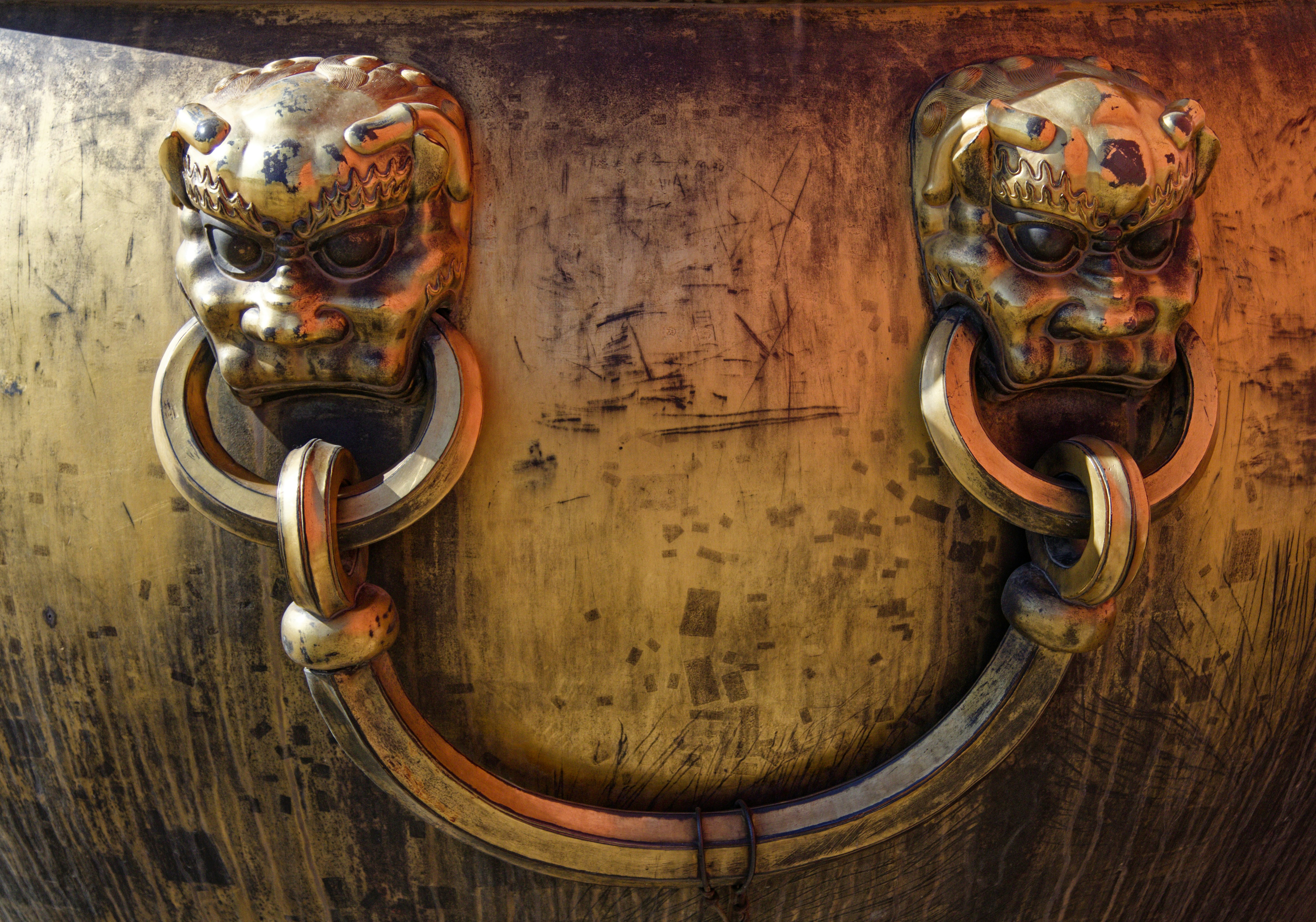 A large wooden barrel with two lions heads on it photo – Free China ...