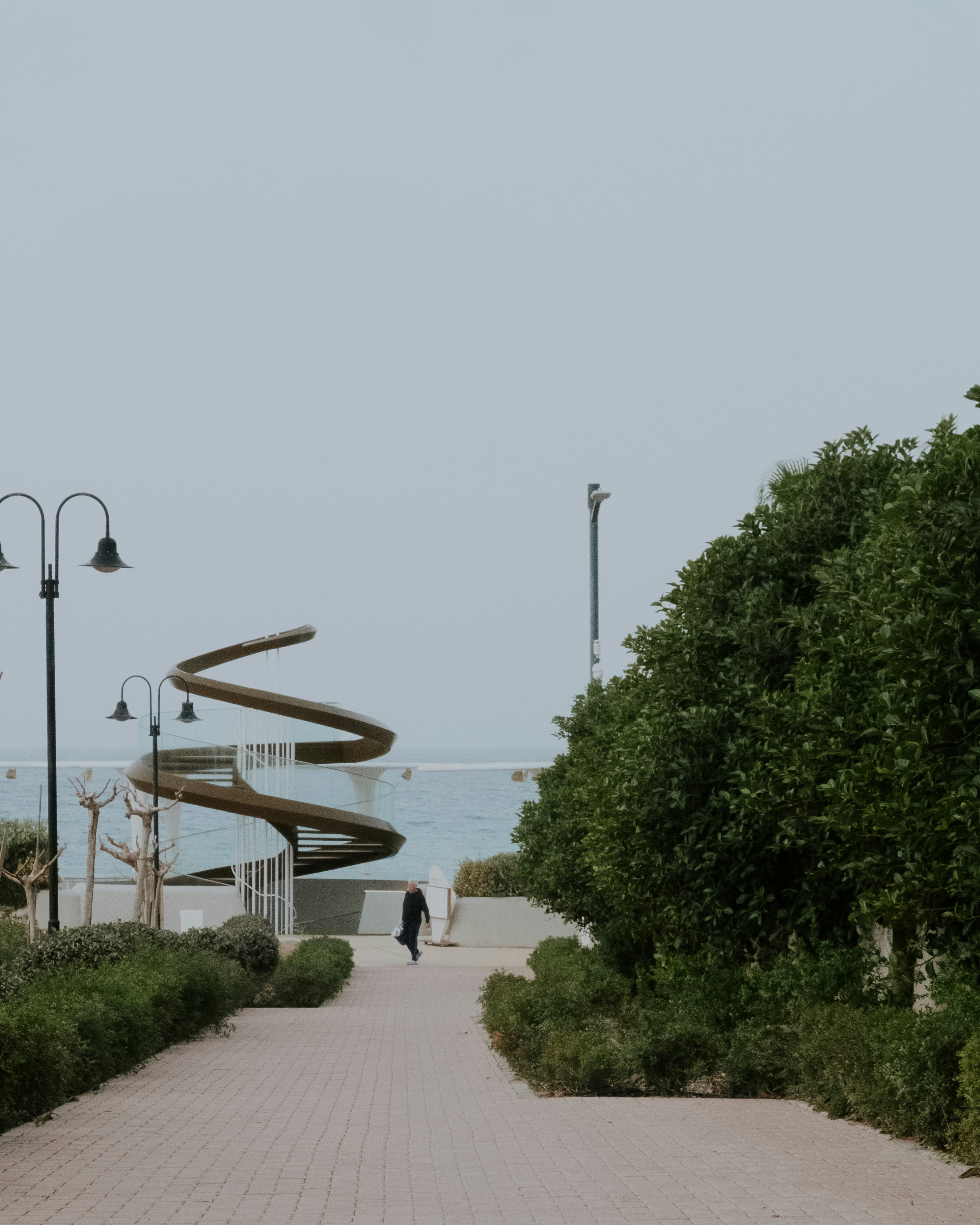 Coastline Walkway with Spiral Slide Framing the Sea