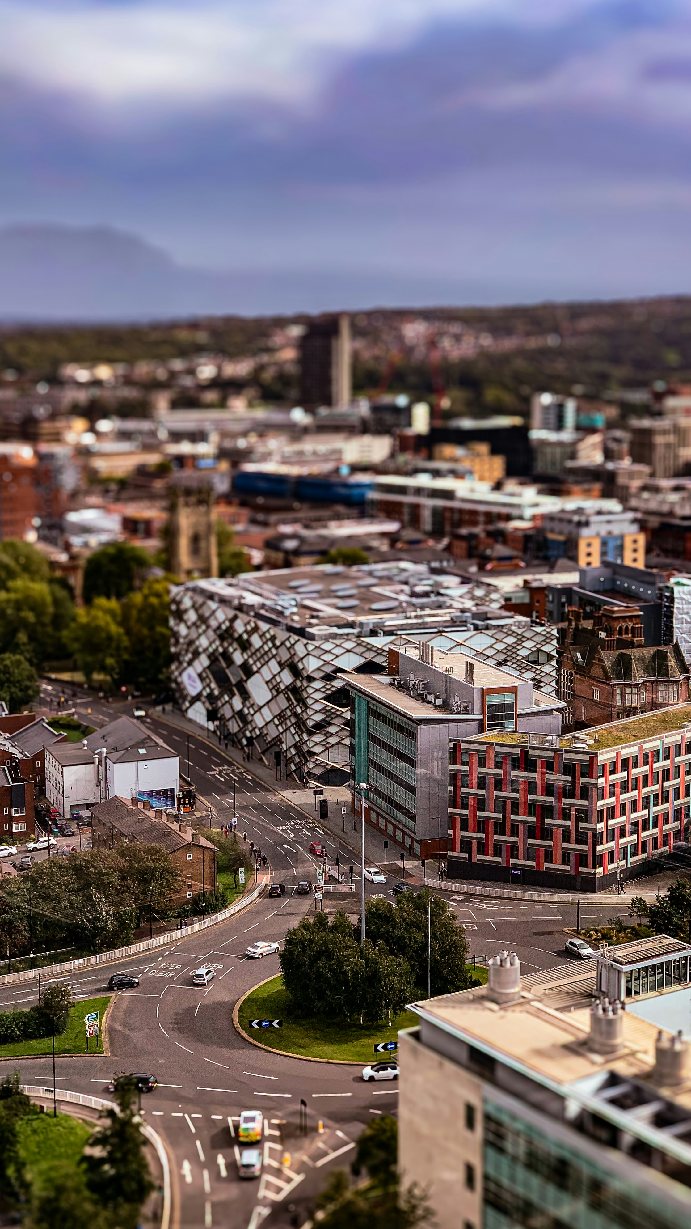 Miniature Sheffield. Shot from inside the top floor of Sheffield University Arts Tower. | an aerial view of a city with tall buildings