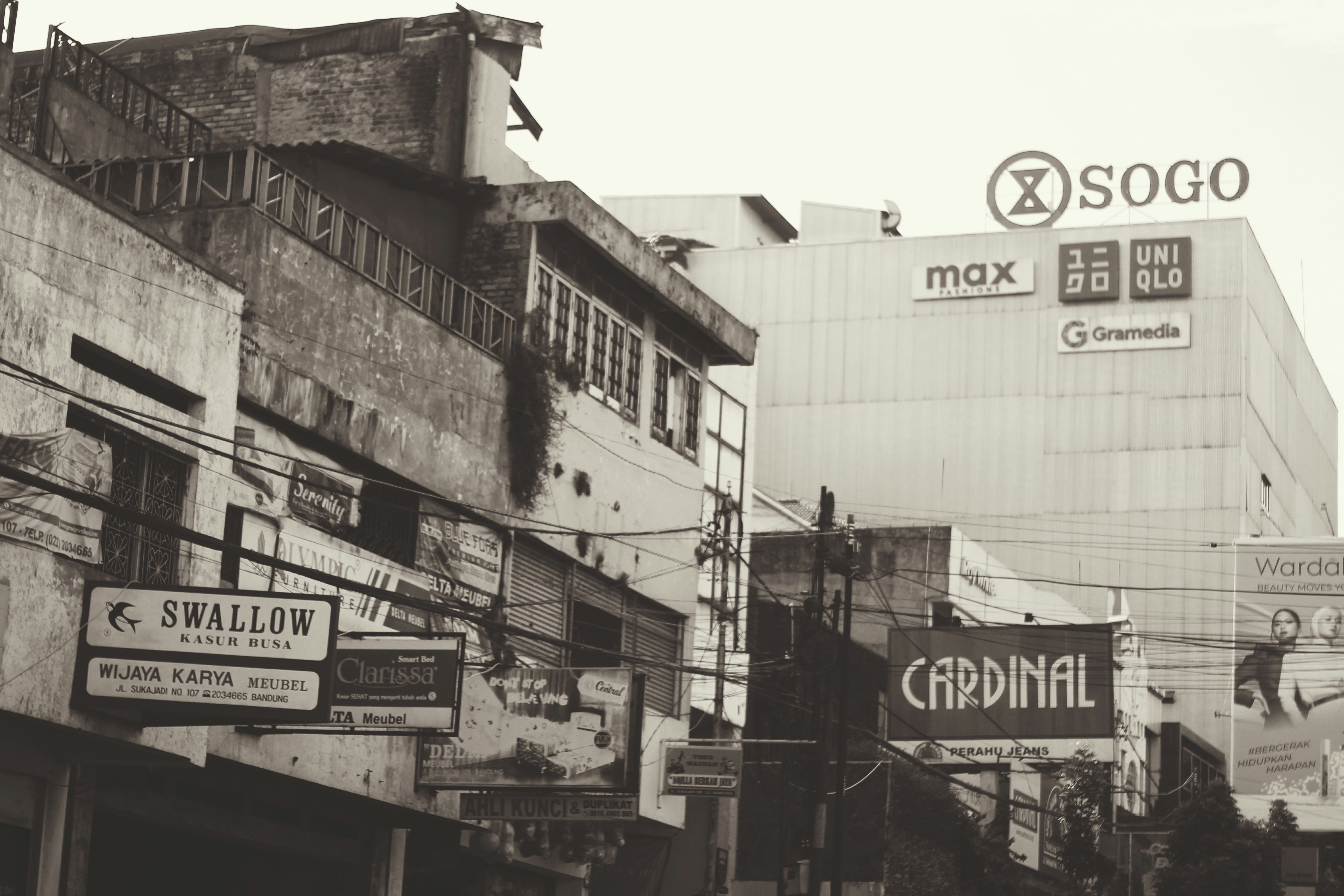 Billboard Alley: Monochrome Retail Signage in a Weathered Street