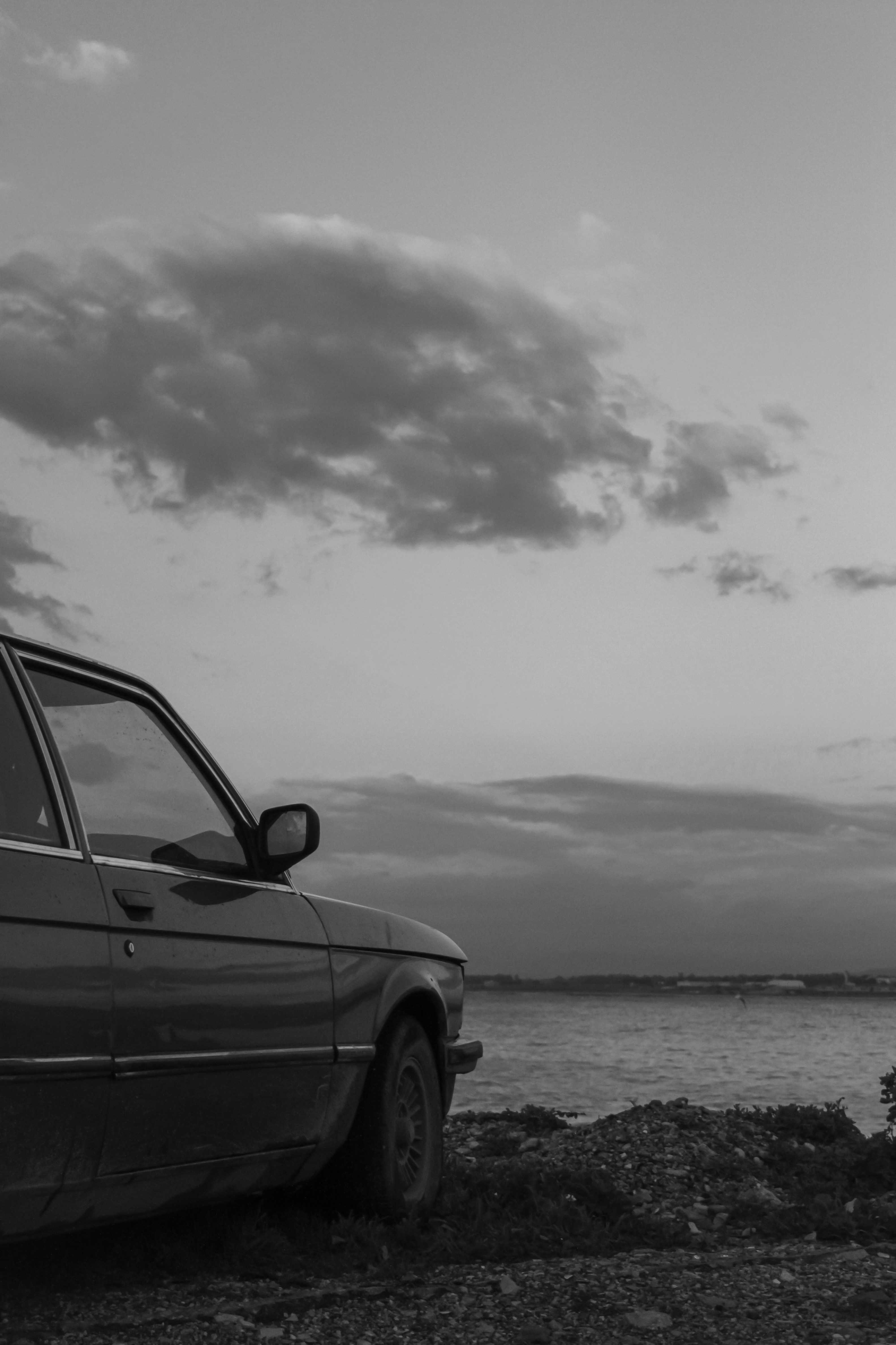 Edge of Tide: A Weathered Sedan Resting by the Quiet Shore