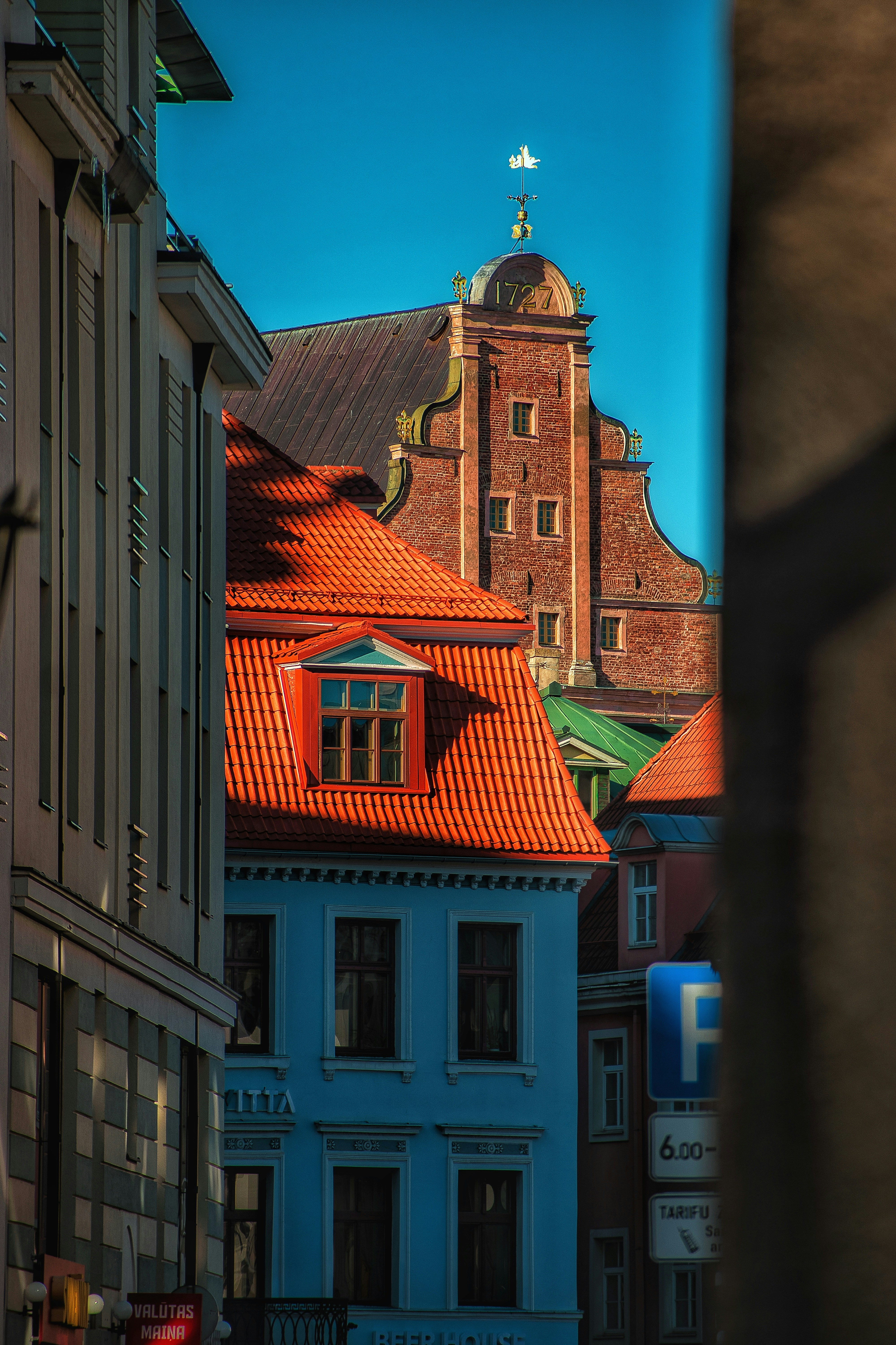 Brick Clocktower Above a Vivid Roofscape