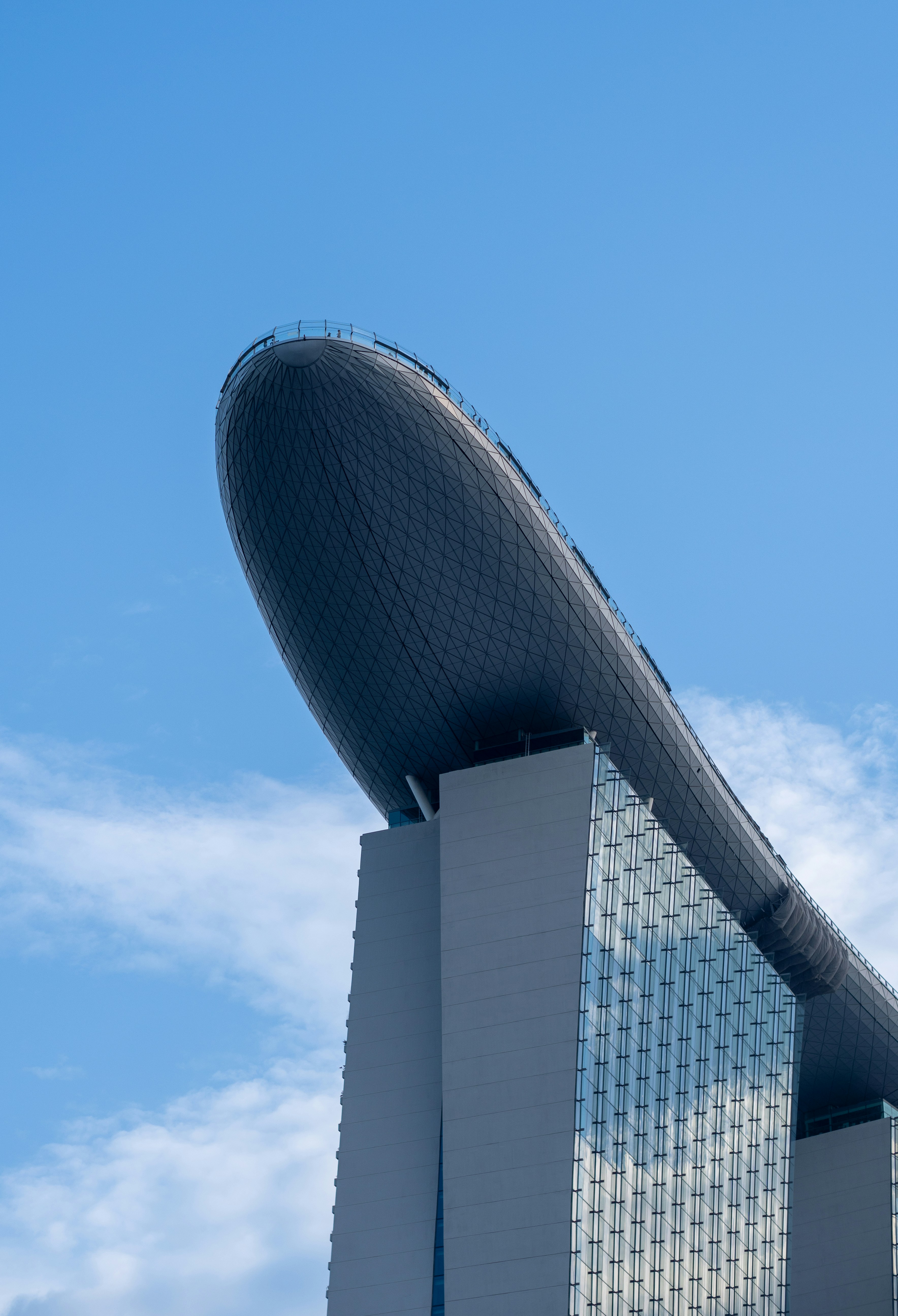 A very tall building with a curved roof photo – Free Singapore Image on ...