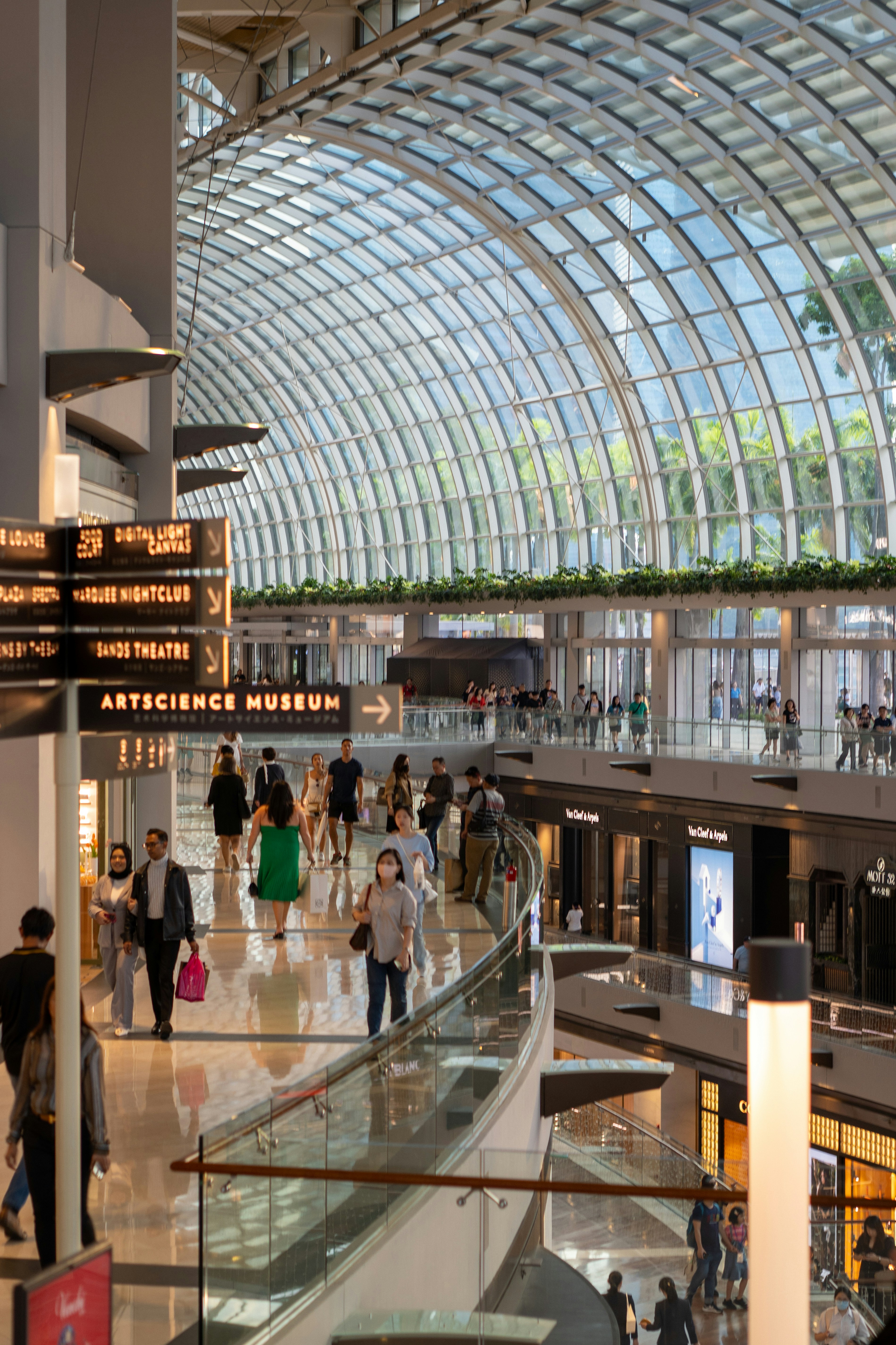 A group of people walking around inside of a building photo – Free ...