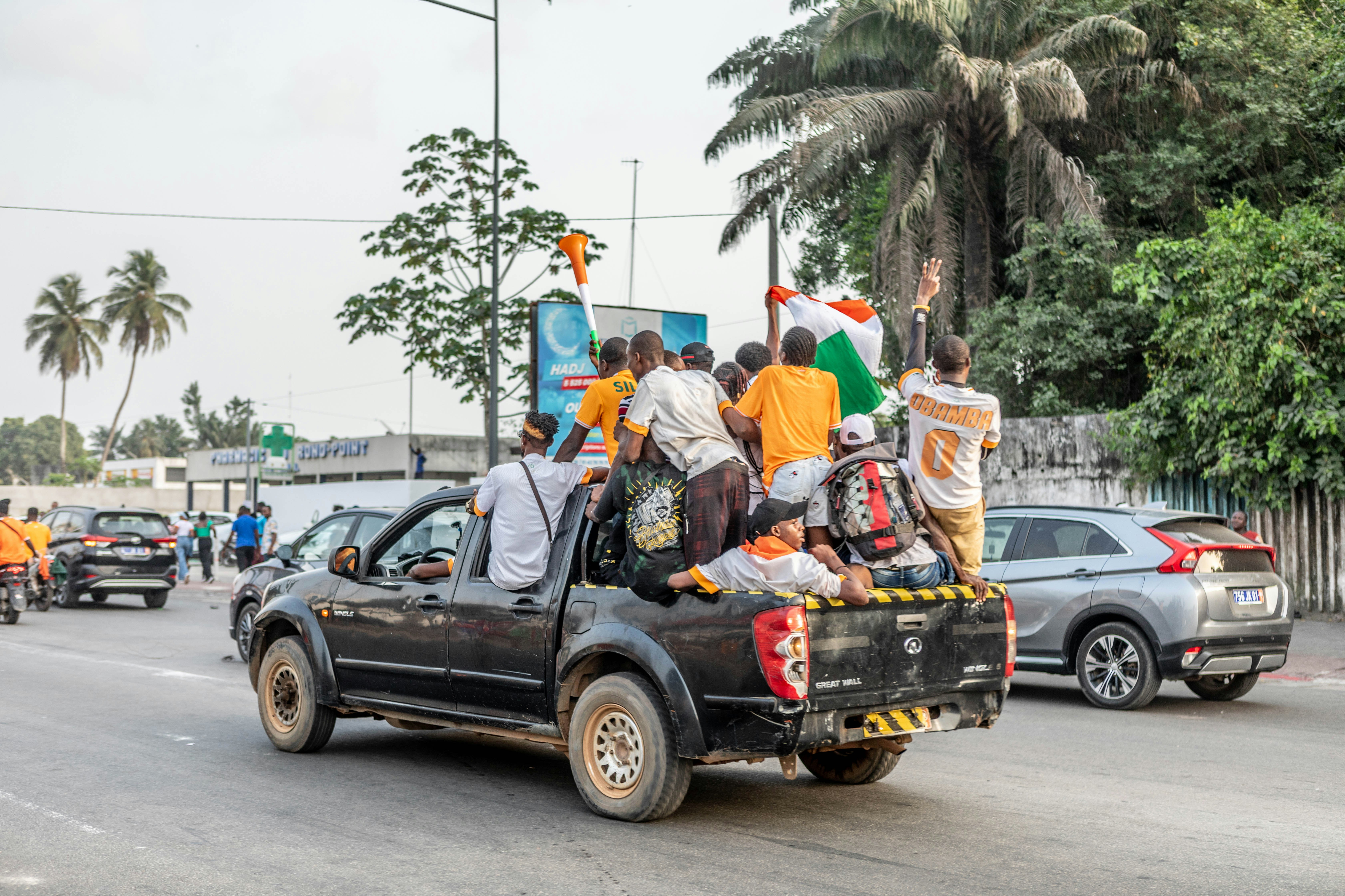 A group of people riding in the back of a truck photo – Free Abidjan ...