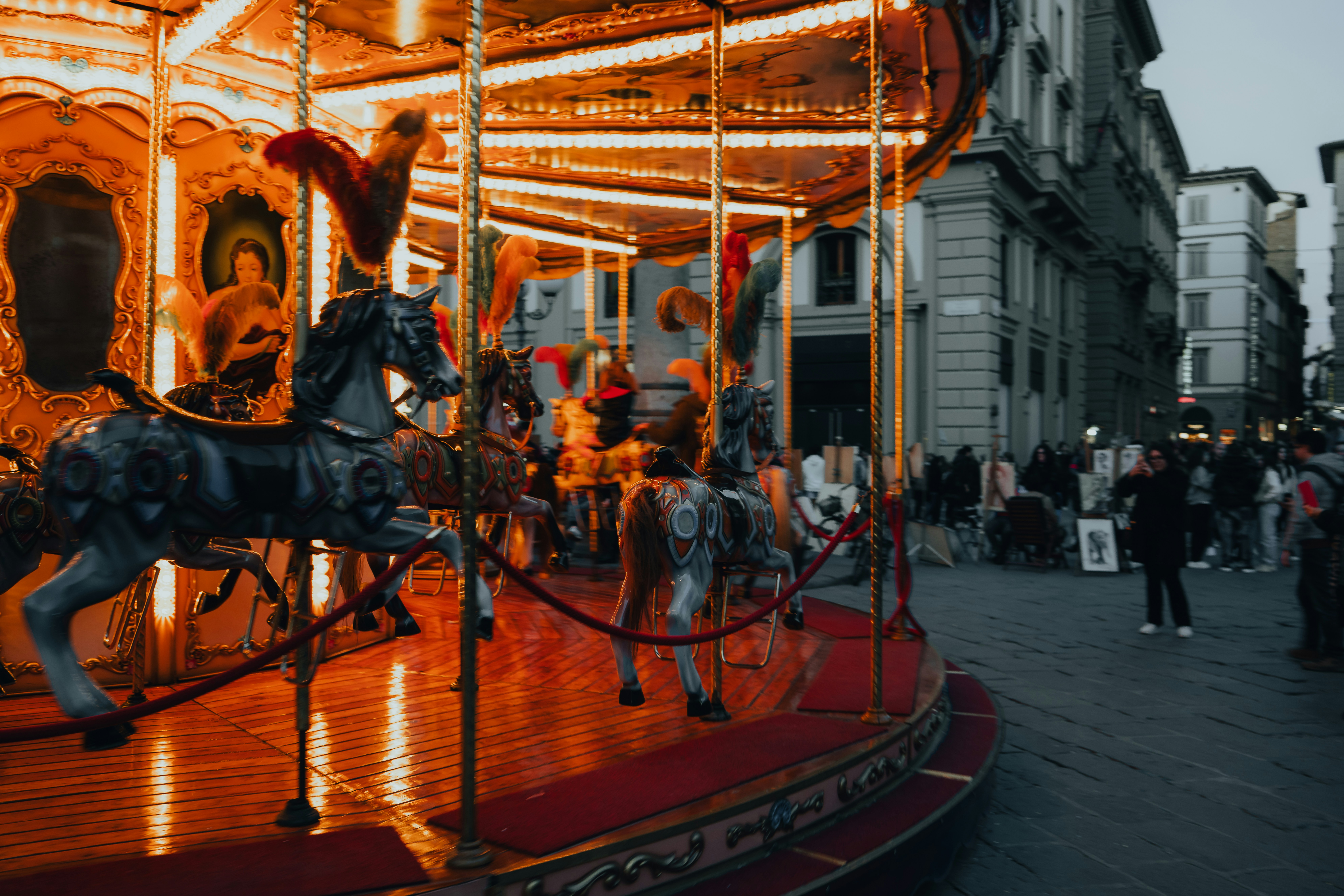 Amber Carousel at Dusk: Warm Light, Moving Horses, City Square