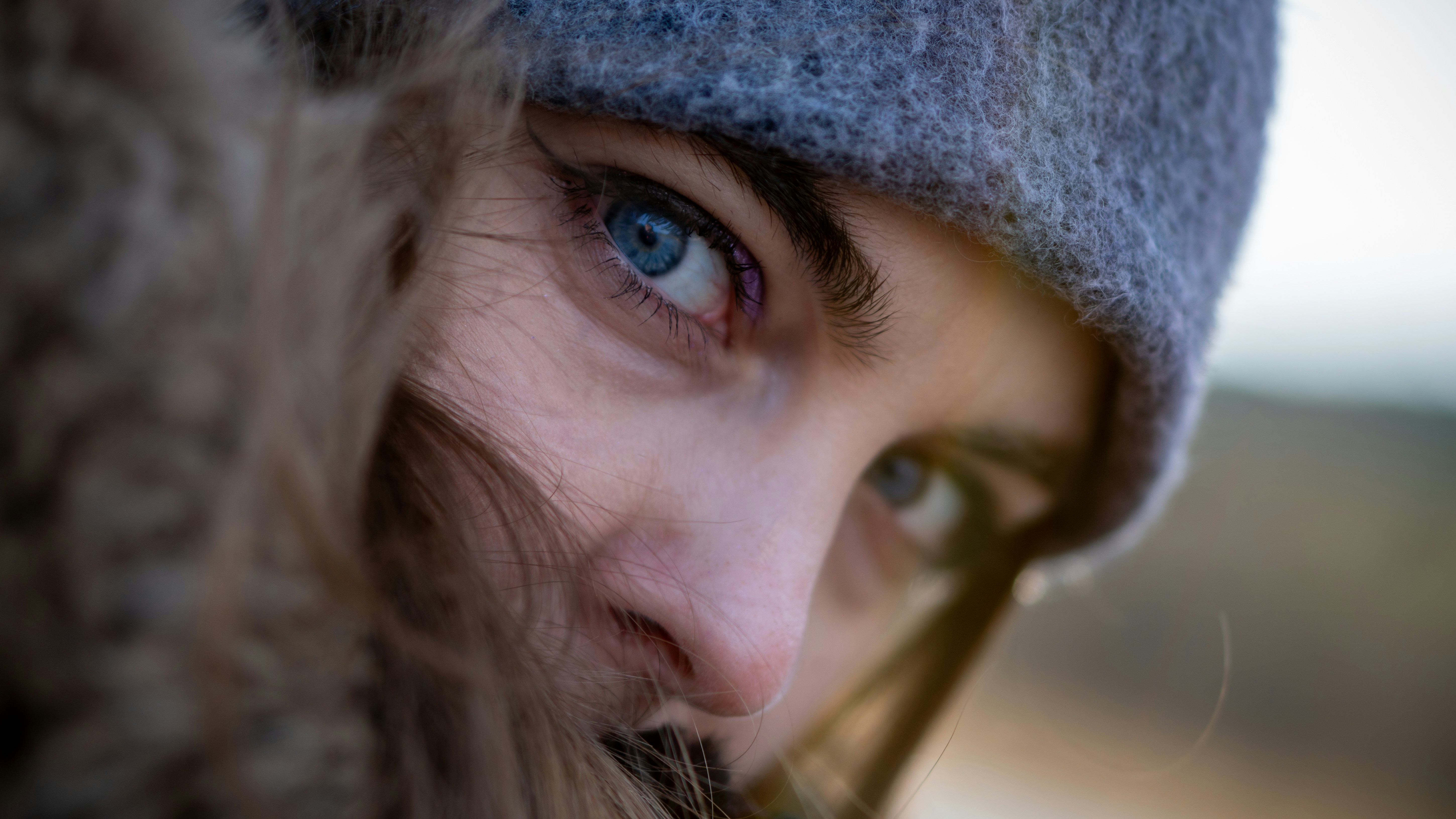 Blue Gaze Under a Woolen Rim