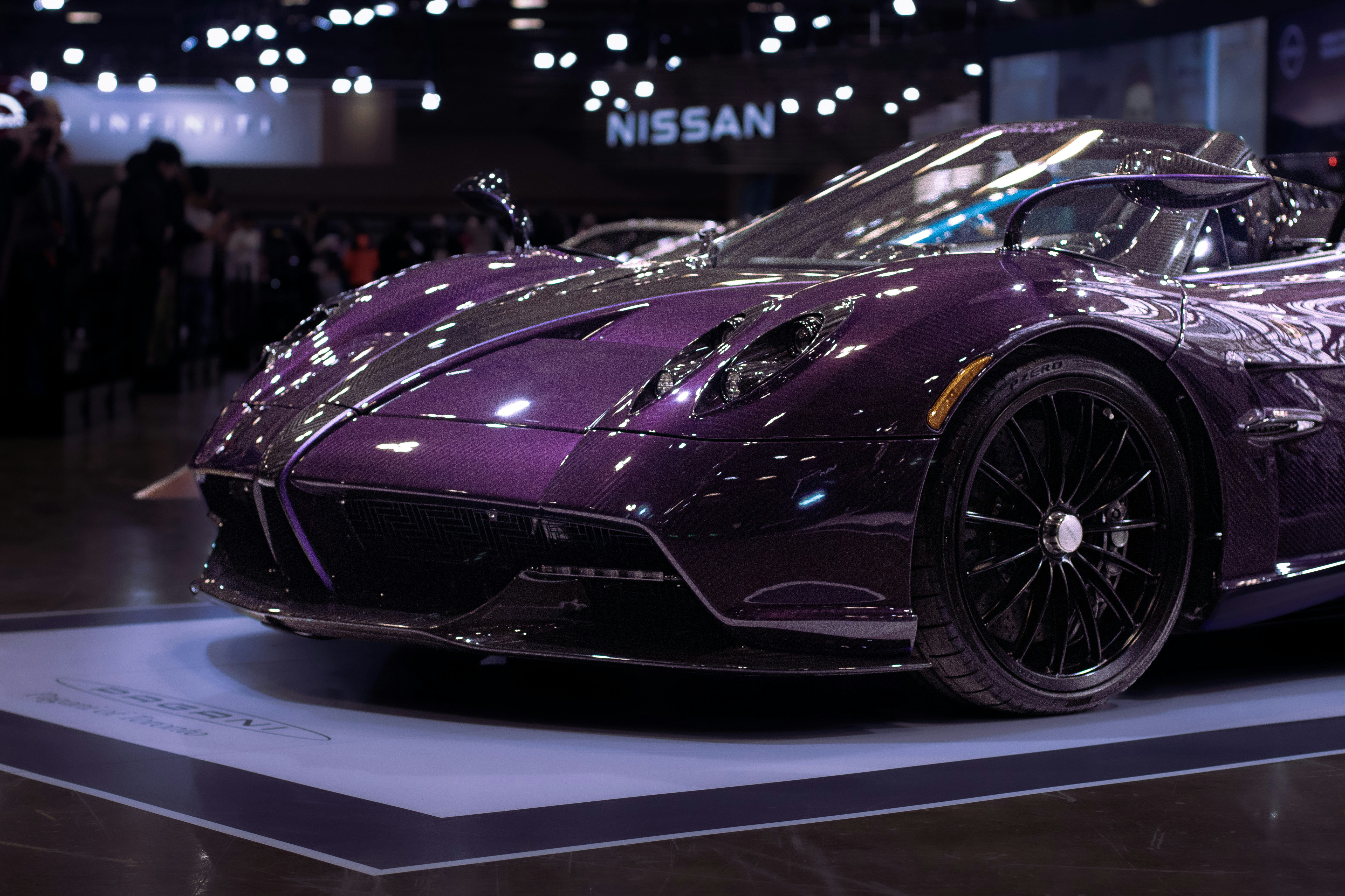 a purple sports car on display at a car show