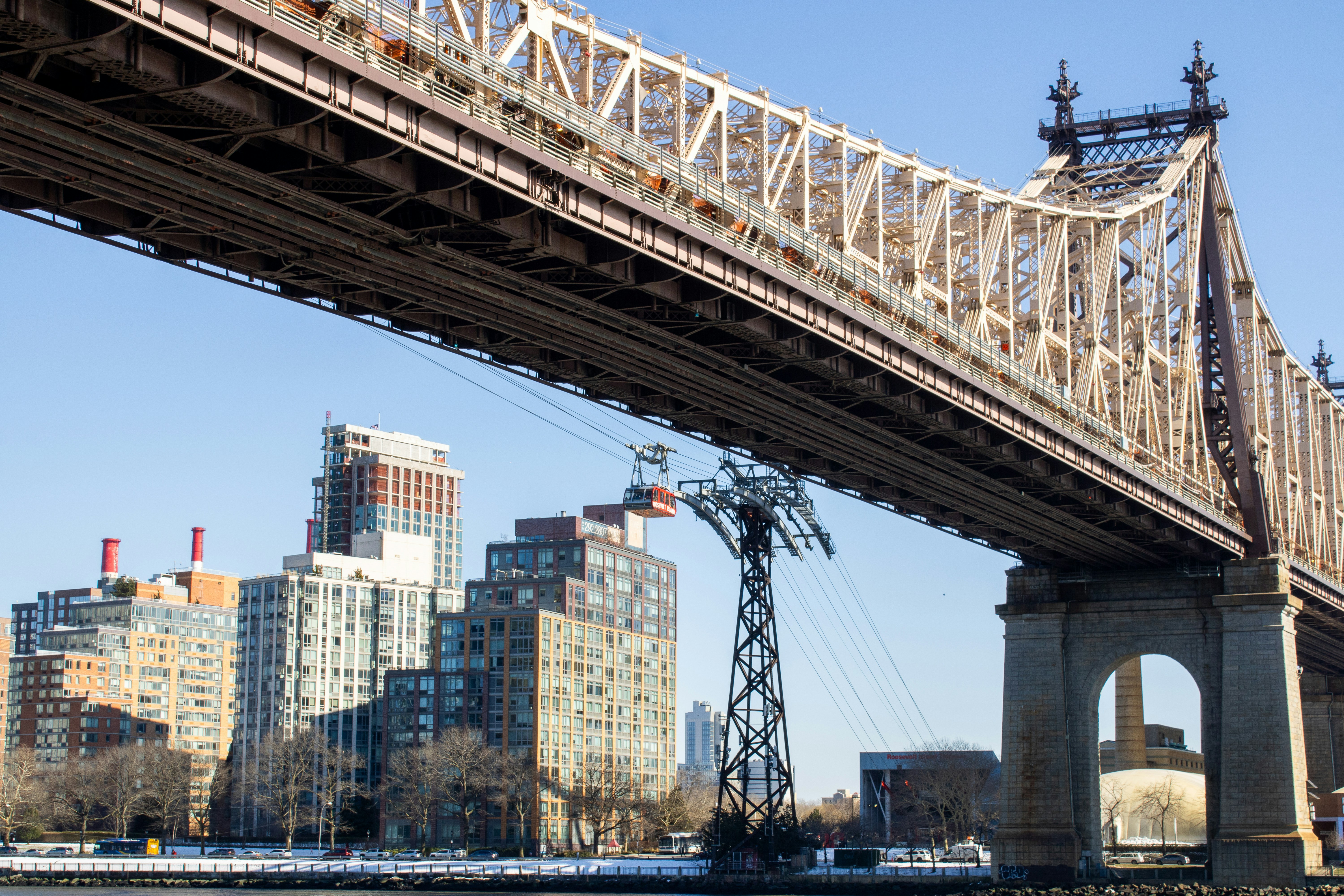 A bridge over a body of water with buildings in the background photo ...