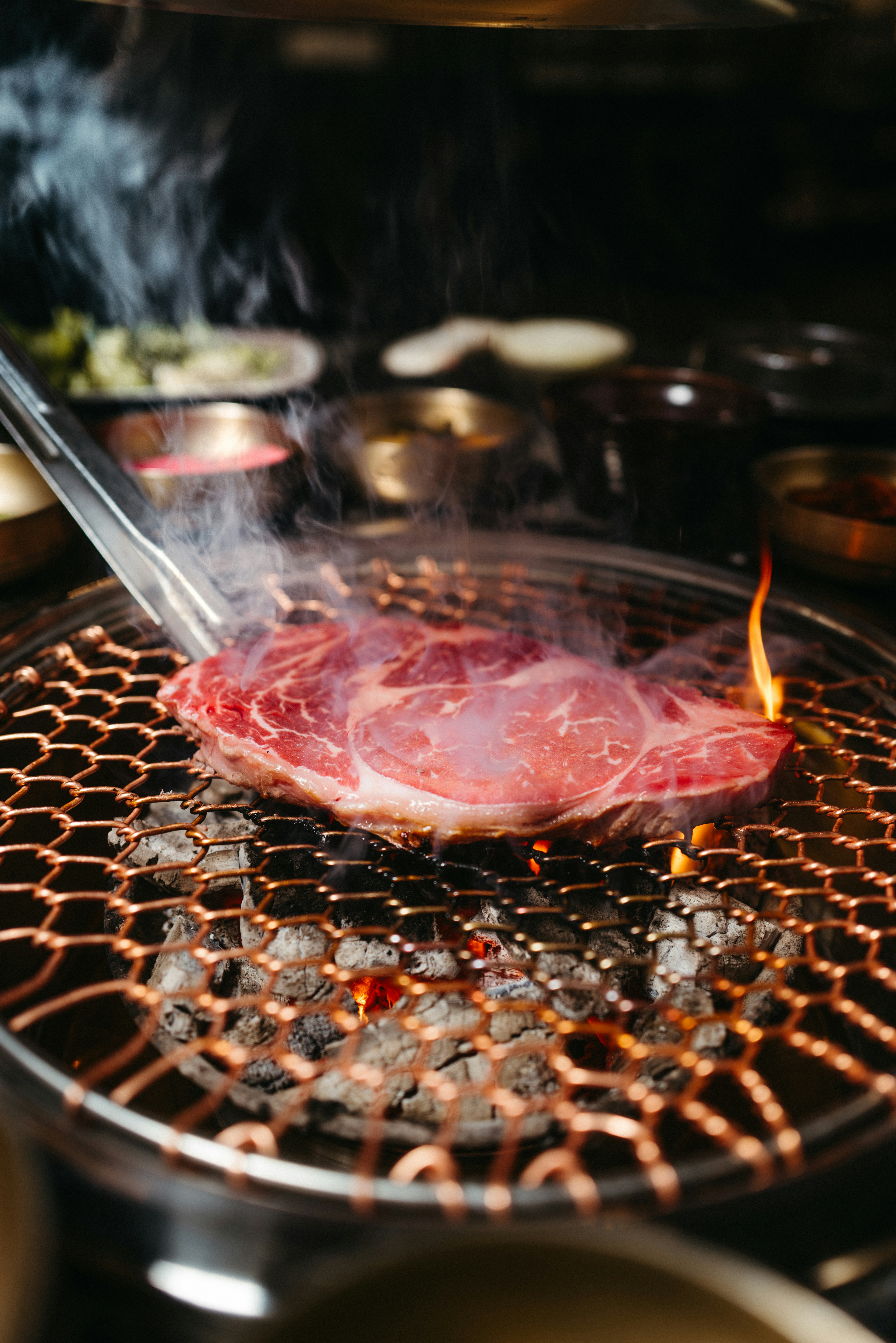 A piece of meat is being cooked on a grill photo – Free Dallas Image on ...