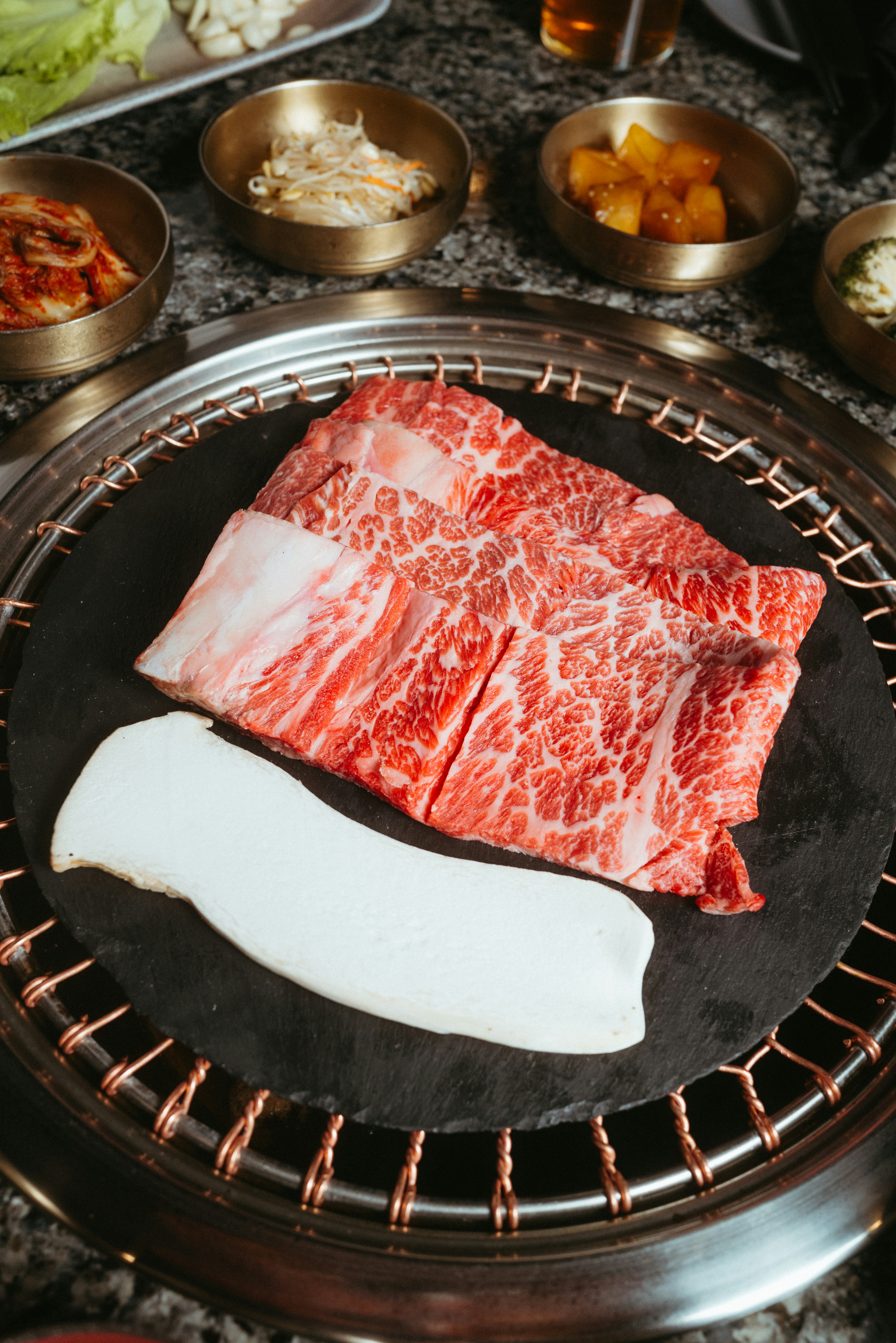 Wagyu Marble on a Circular Grill: Slices Await the Sear