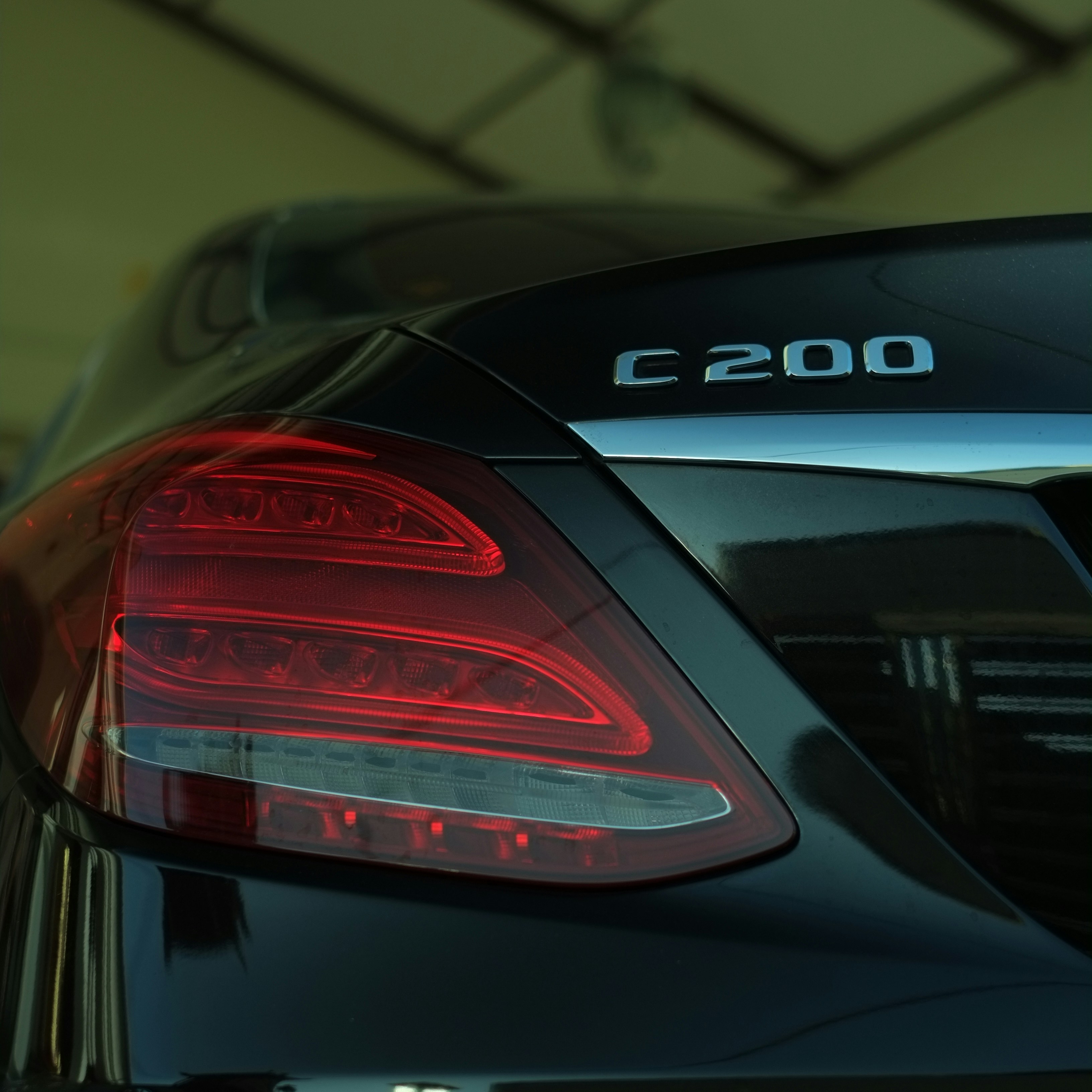 Midnight Crest: Rear view of a Mercedes-Benz C200 with glowing taillights