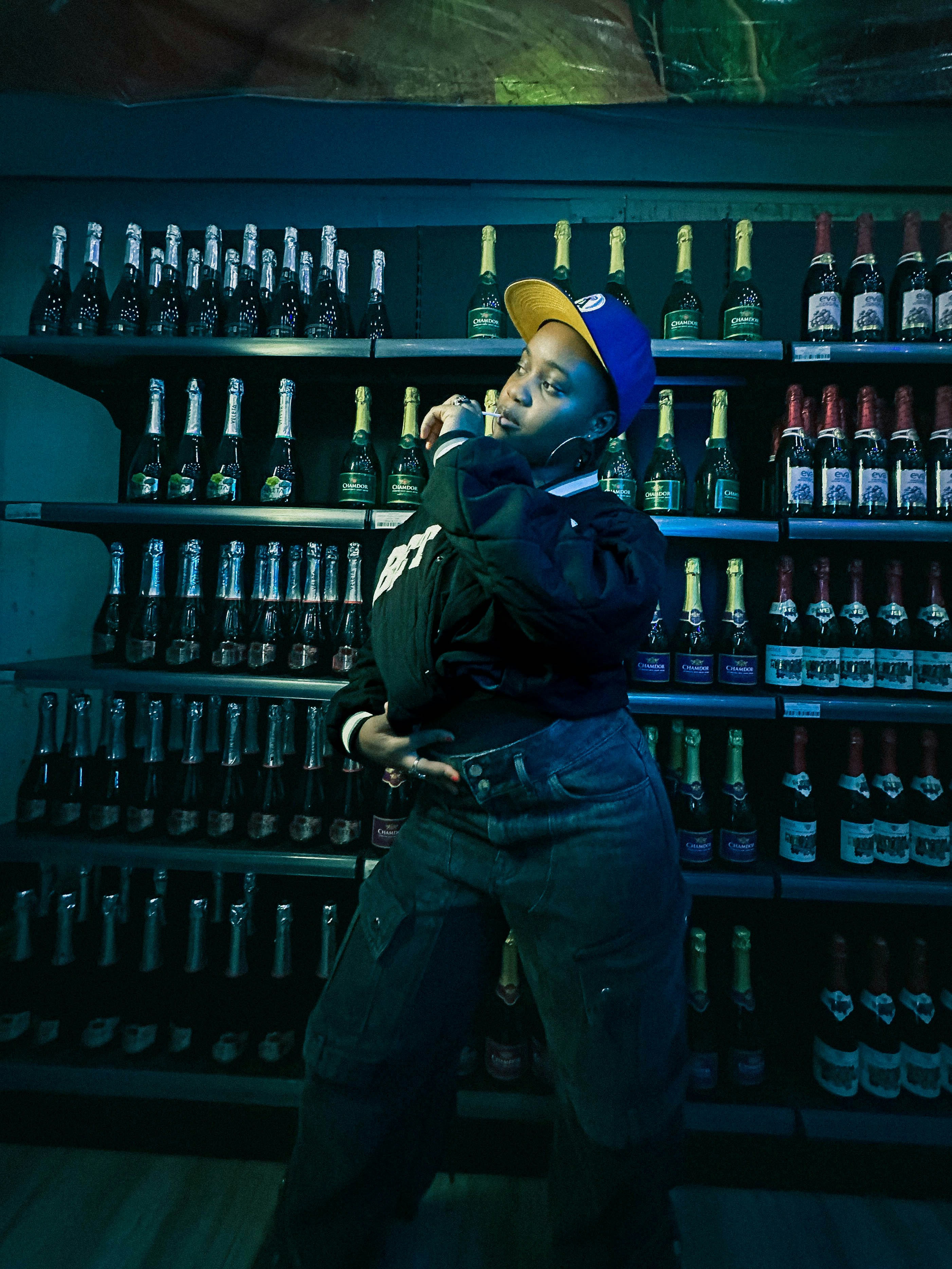 Midnight in the Aisle: A Bold Pose Between Bottles