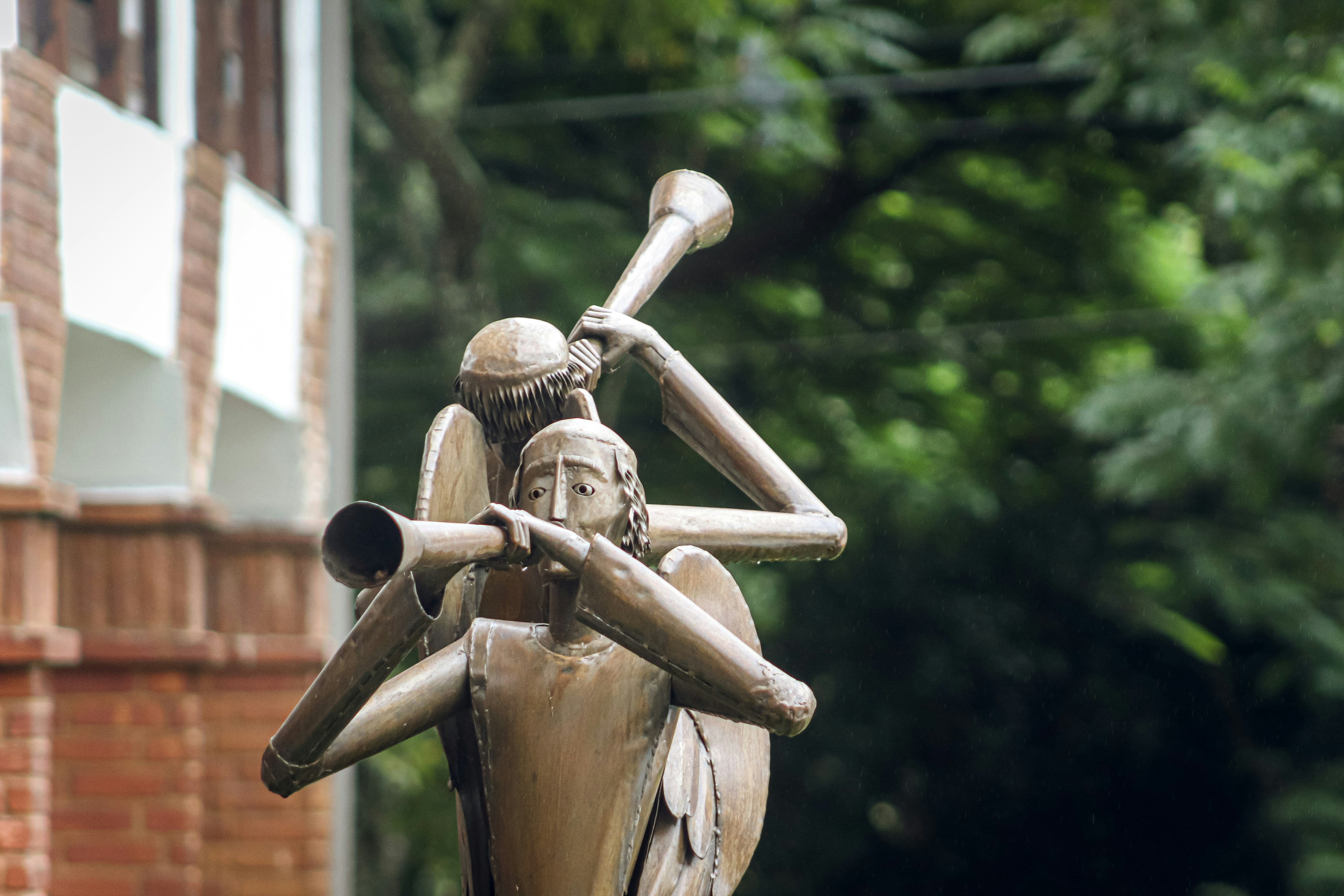 Wooden Street-Scene Maestro: A Bronze Statue in Concert