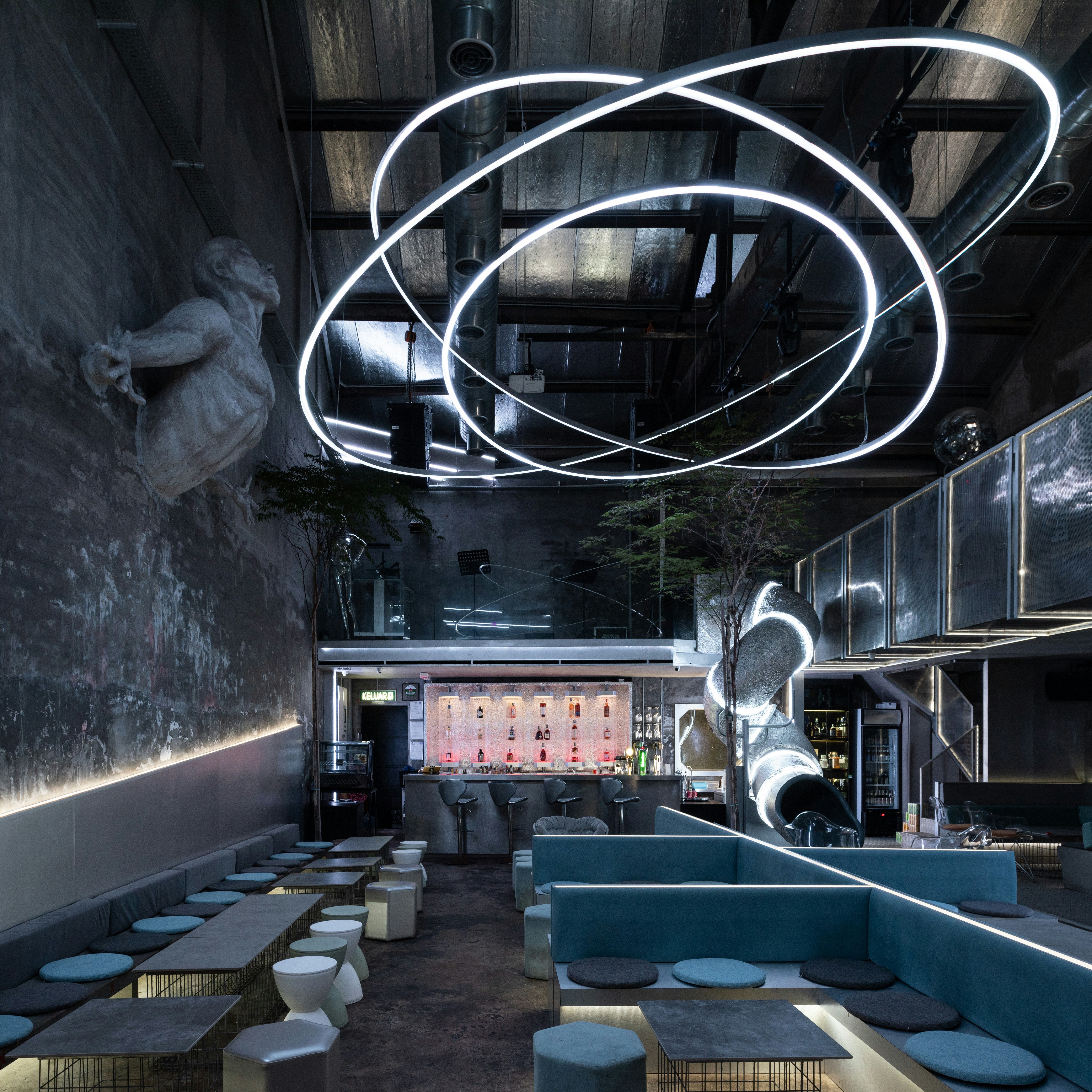 Neon Orbits Over a Moody Industrial Lounge