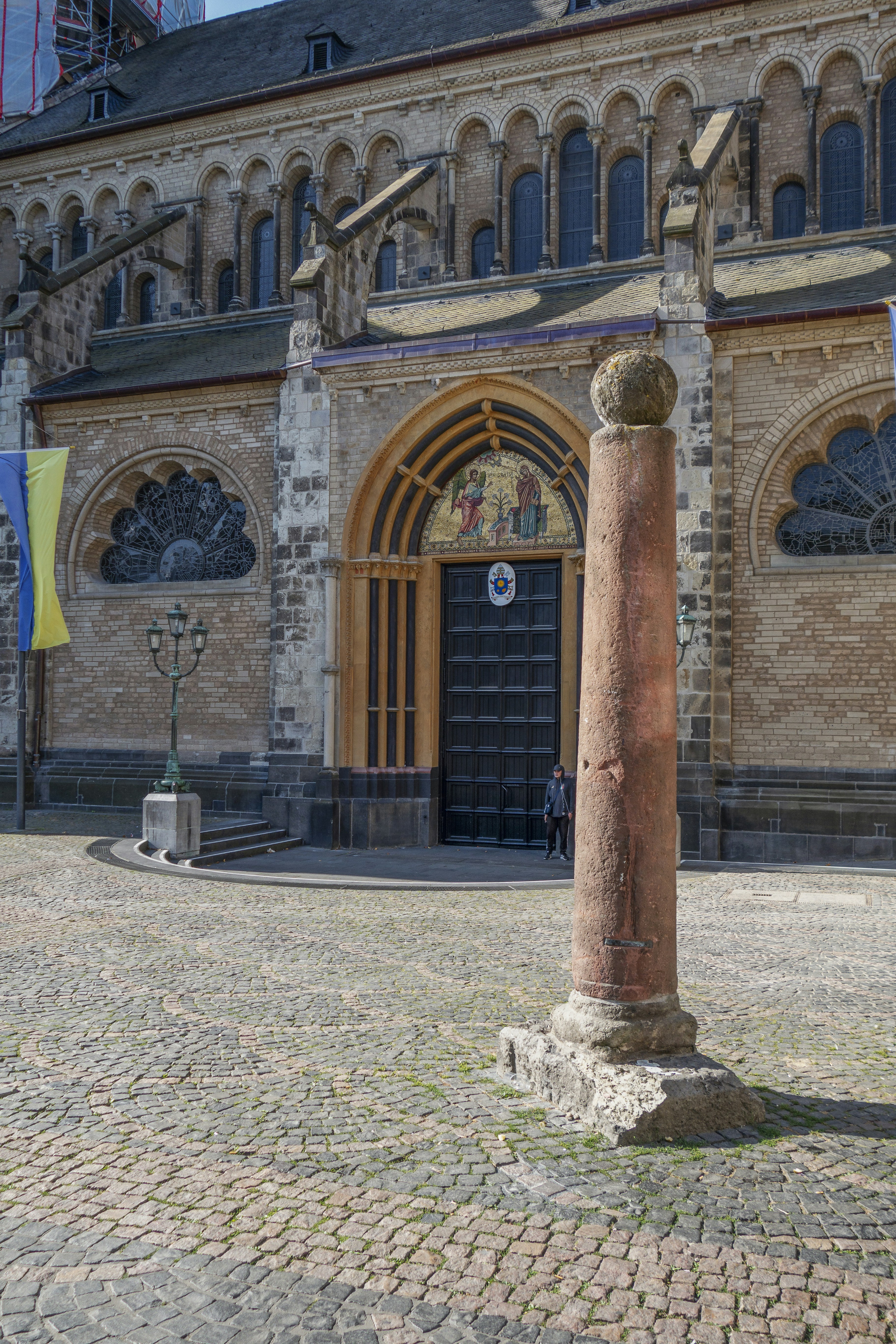 a large building with a tall stone column in front of it