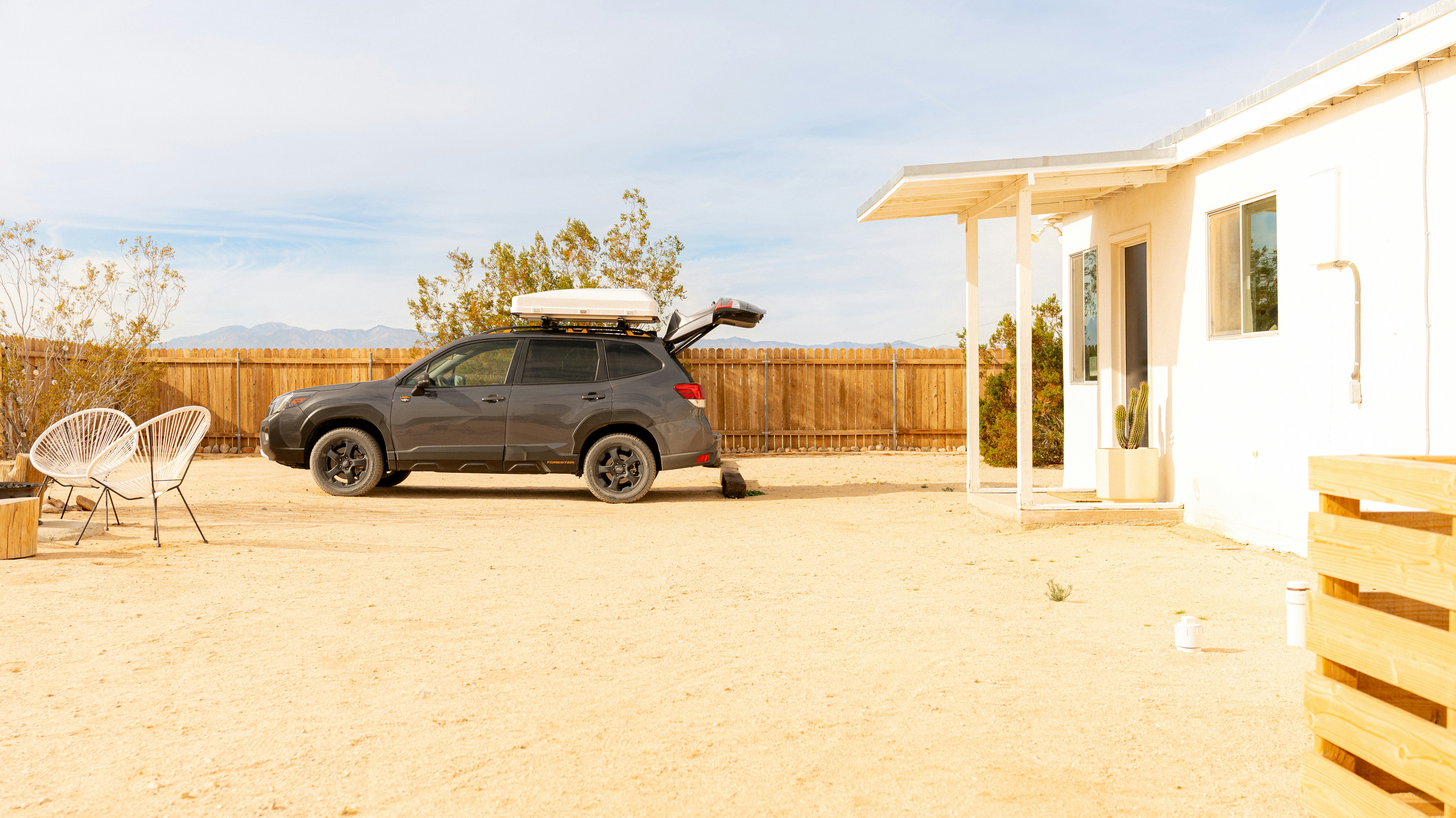 Sunlit Driveway Rendezvous: A Rugged SUV by a Quiet Desert Home
