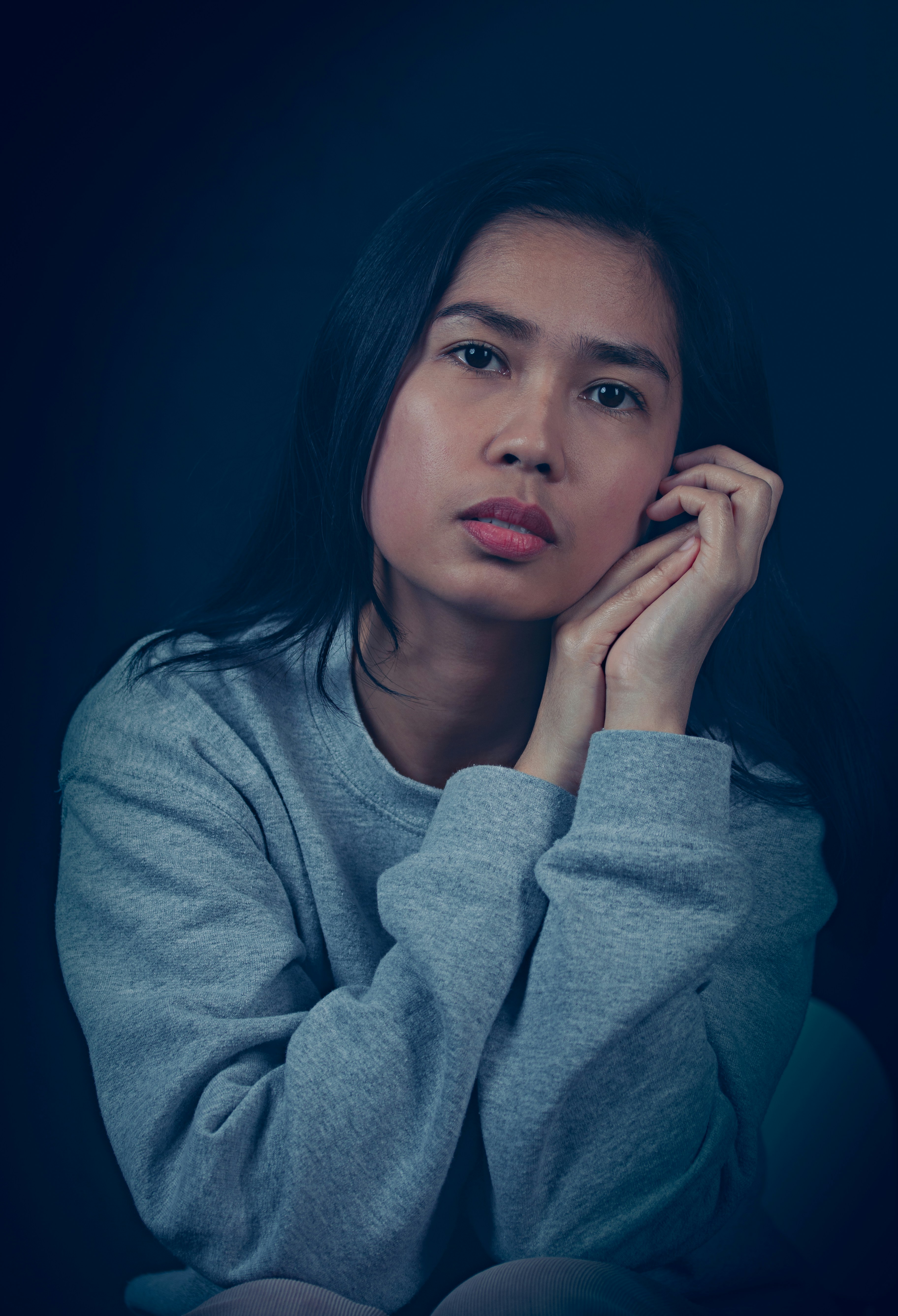 A woman with her hand on her chin photo – Free Portrait photo Image on ...