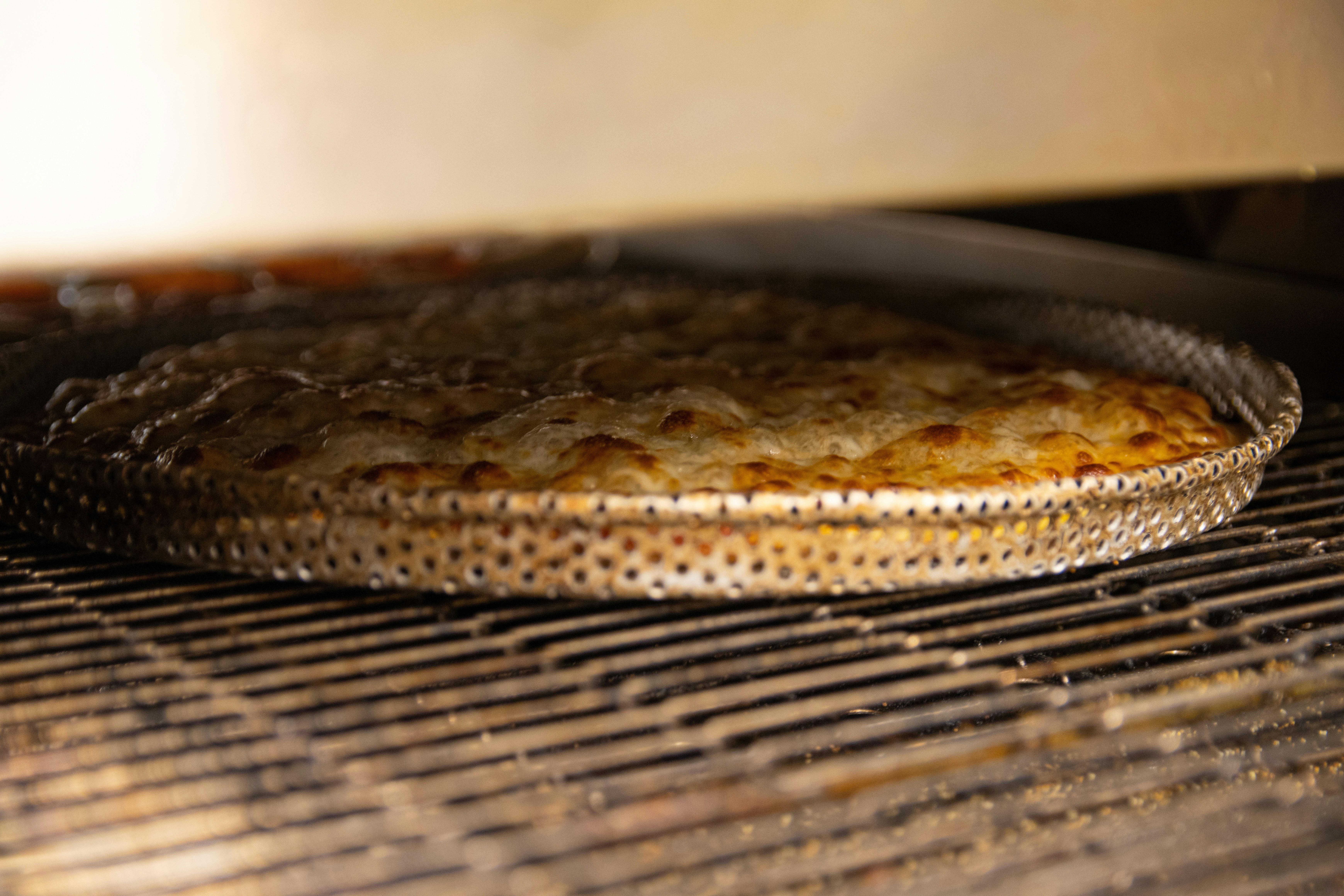 Grill-Level Golden: Pizza Crust Crisping Beneath the Ember Hood