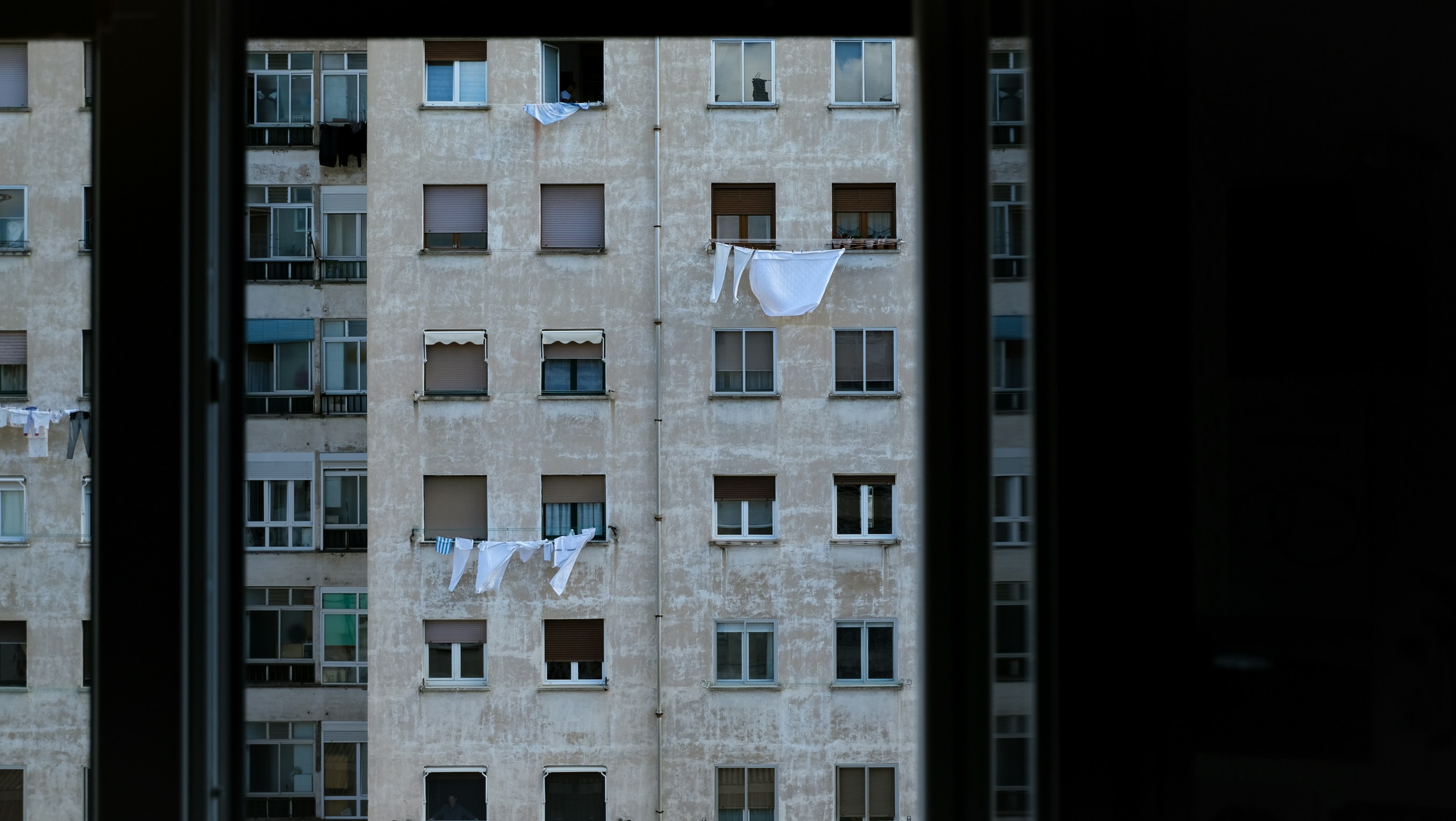 A window with clothes hanging out of it photo – Free Grey Image on Unsplash