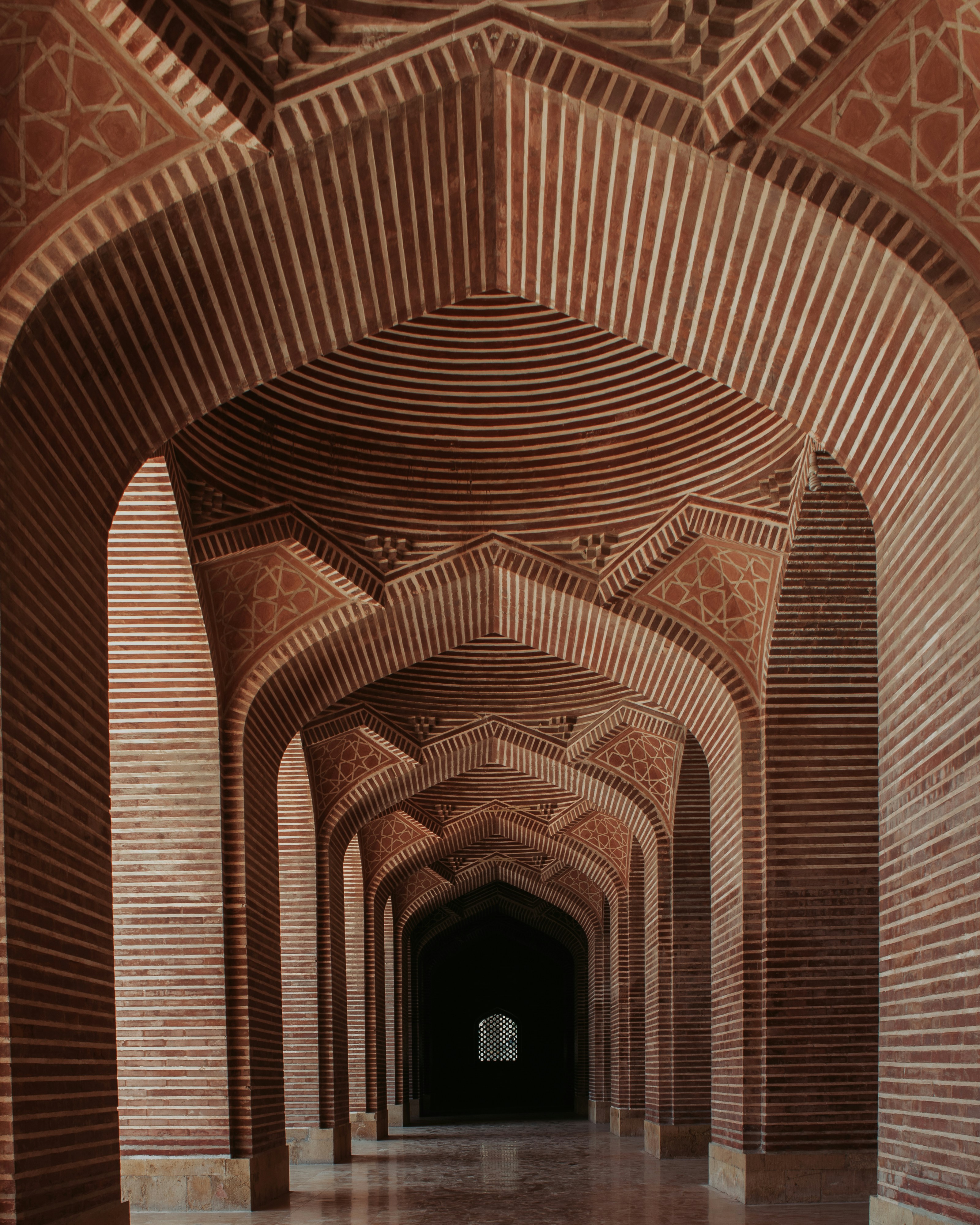Echoes of Brick: A Long Corridor of Receding Arches