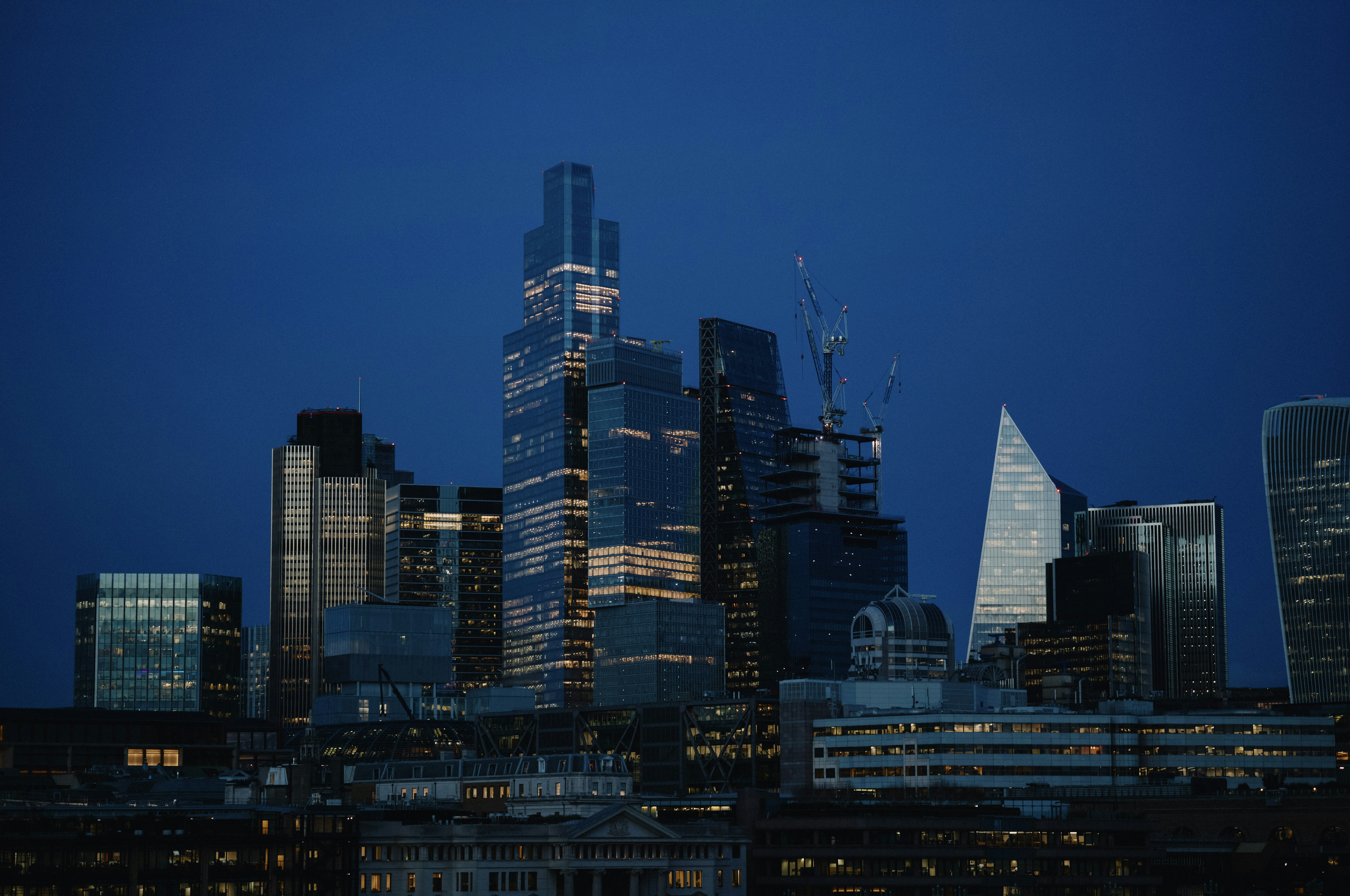 A city skyline with skyscrapers lit up at night photo – Free City Image ...