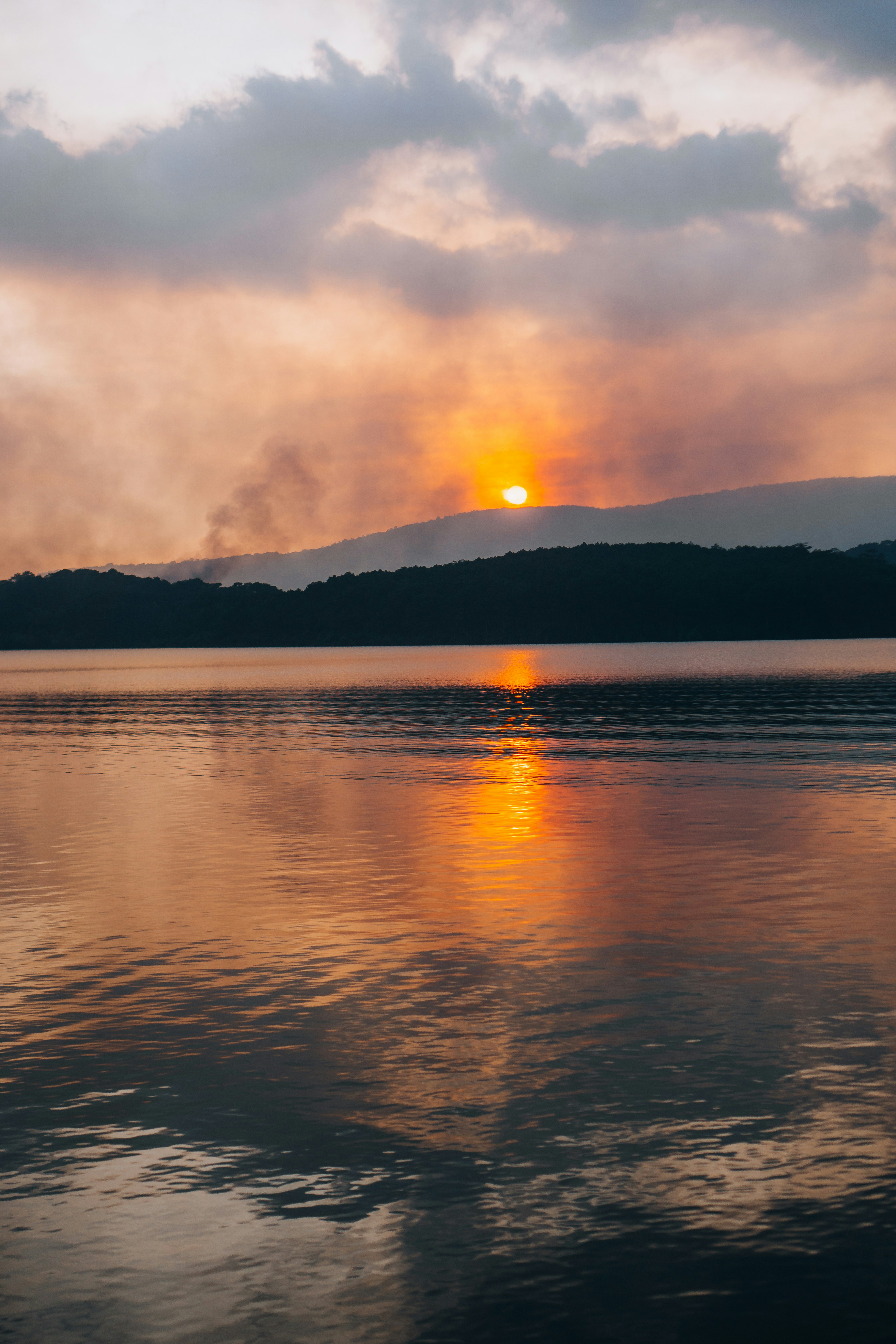 Molten Sun over a Quiet Lake: Sunset Paints Mist and Ripples