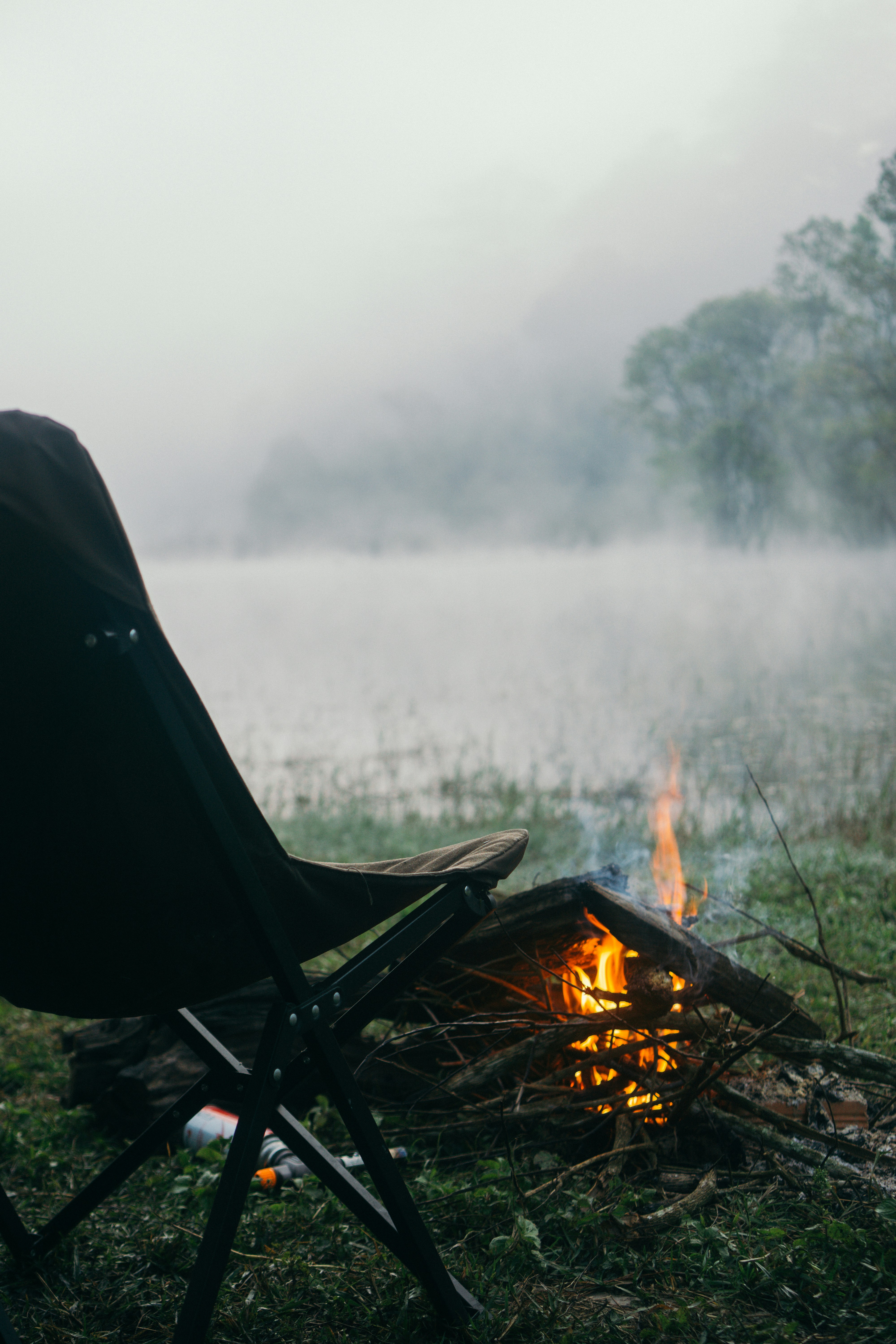 Ember at the Lake's Edge: Firelight Framing a Misty Morning