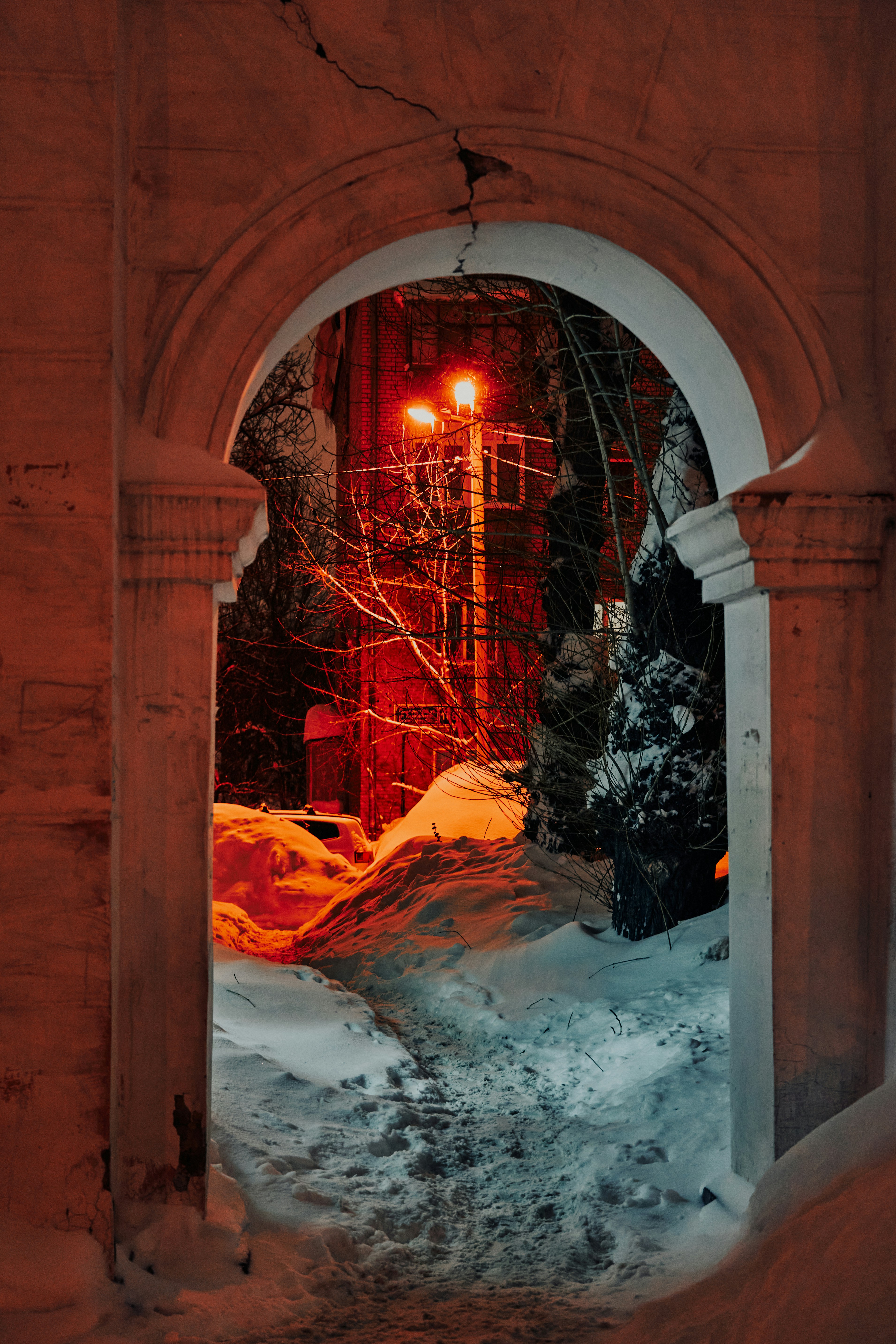 Crimson Lanterns Framing a Snowbound Archway