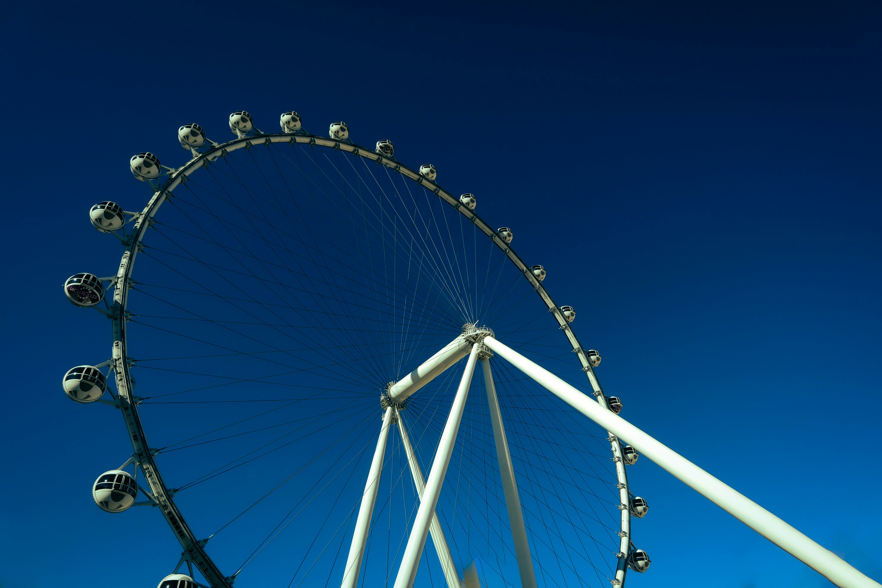 Converging Arcs: White Ferris-Wheel Skeleton Against a Velvet Indigo Sky
